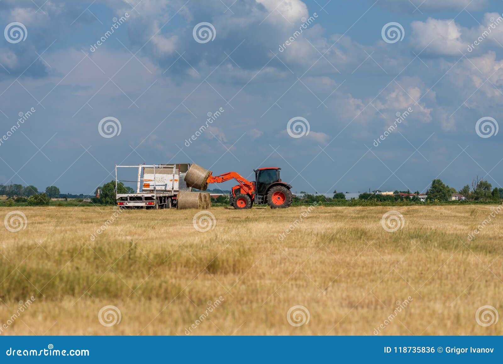 Tractor Lifting Hay Bale on Barrow. Stock Photo - Image of harvest ...