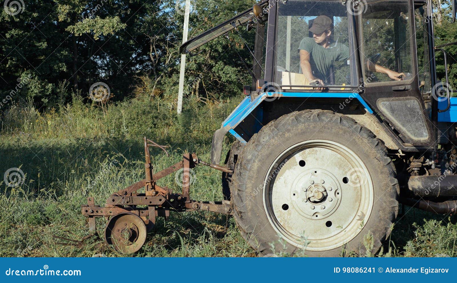 Tractor Working on the Potato Field. Harvesting Potatoes with Using ...