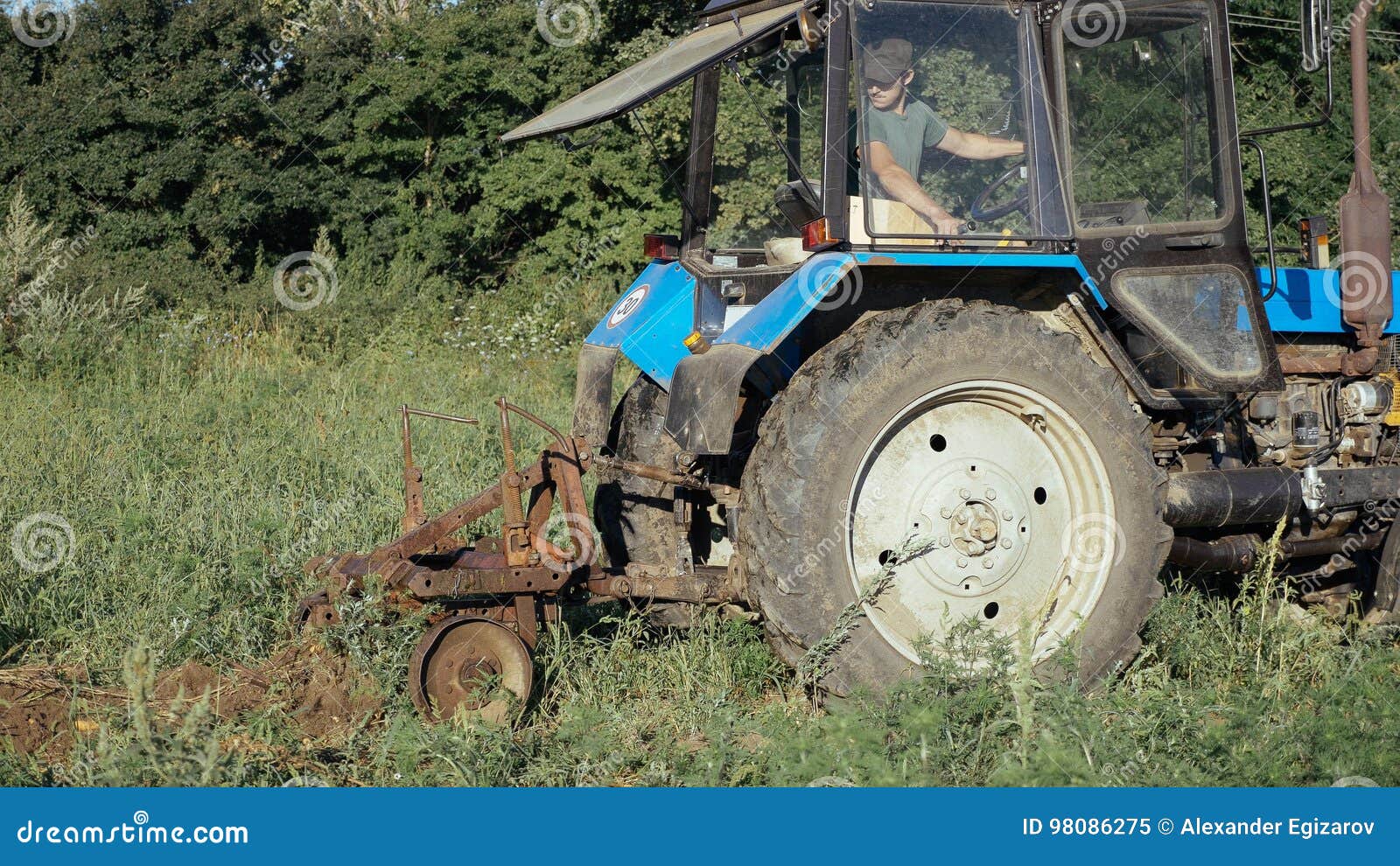 Tractor Working on the Potato Field. Harvesting Potatoes with Using ...