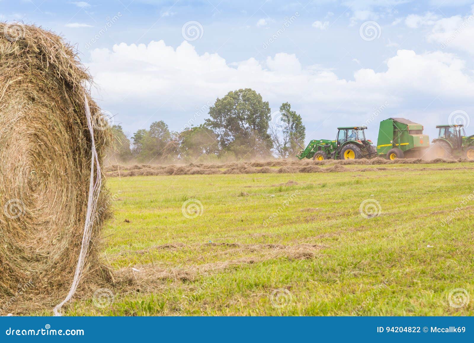Tractors and Hay Roll in a Field Editorial Photography - Image of roll ...