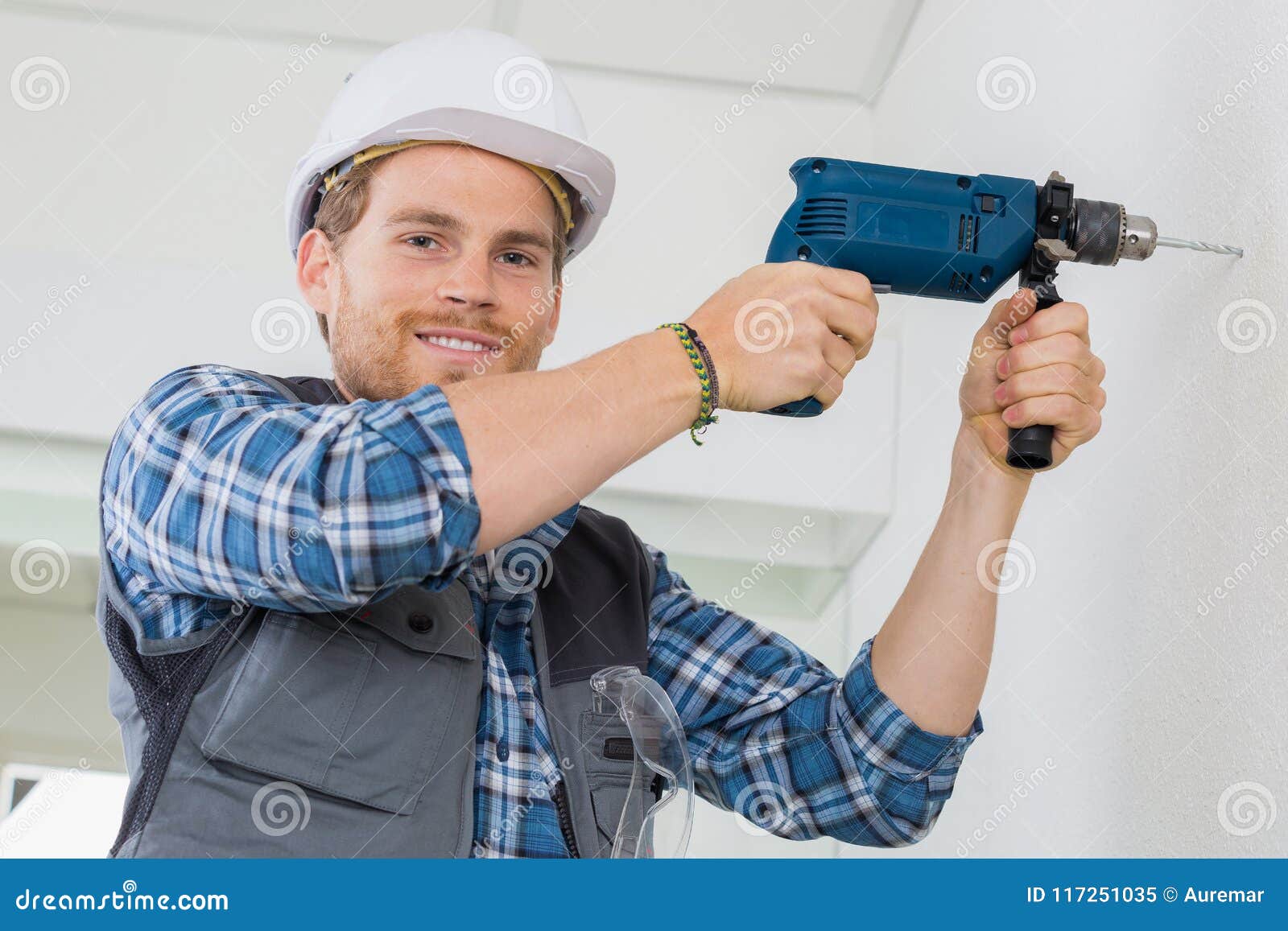 Tradesman Drilling at Construction Site Stock Image - Image of blue ...