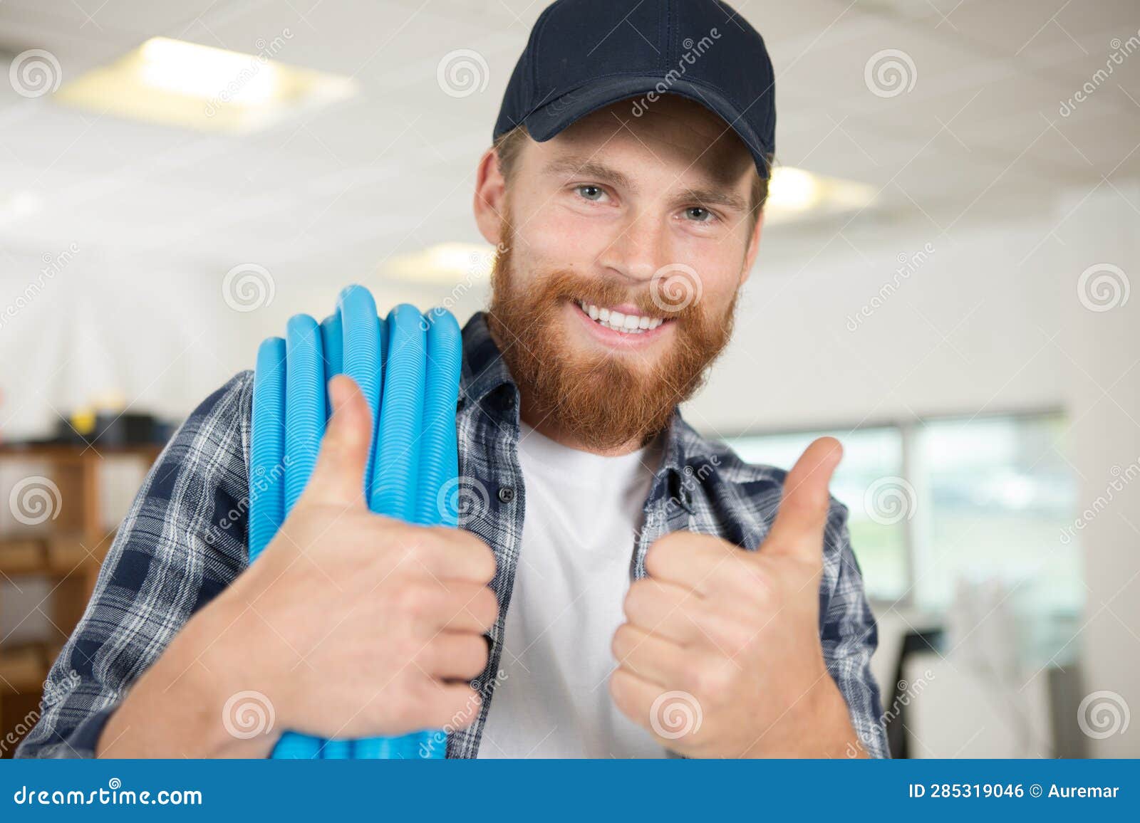 Tradesman with Reel Cable on Shoulder Giving Thumbs Up Stock Photo ...