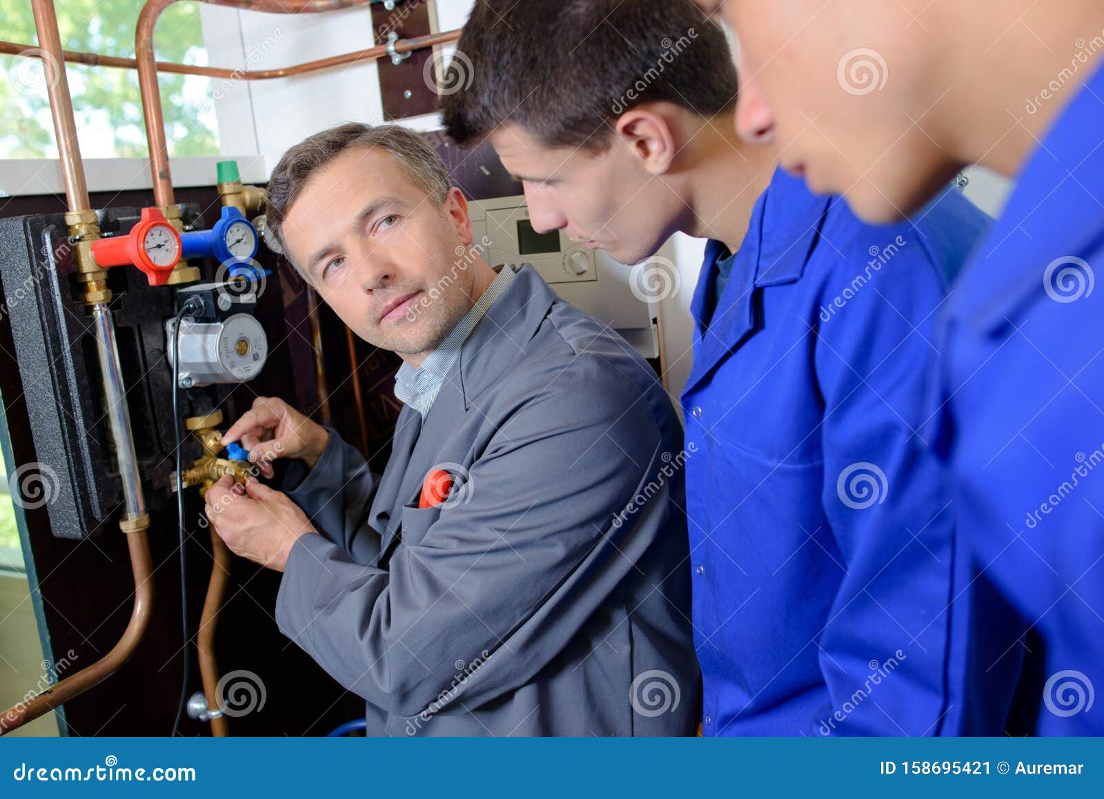 Tradesman Training Two Apprentices Stock Image - Image of tradesman ...