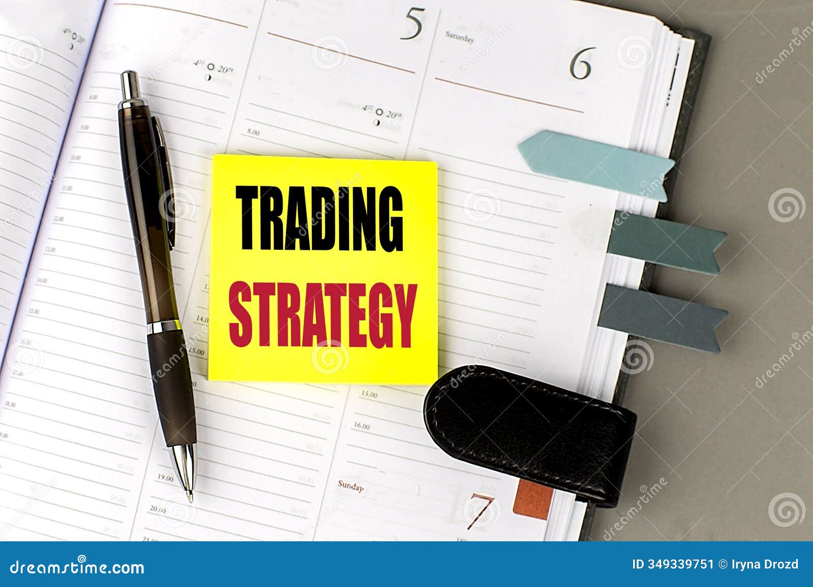 Trading Strategy Concept with Planner, Yellow Sticky Note, Pen, and ...