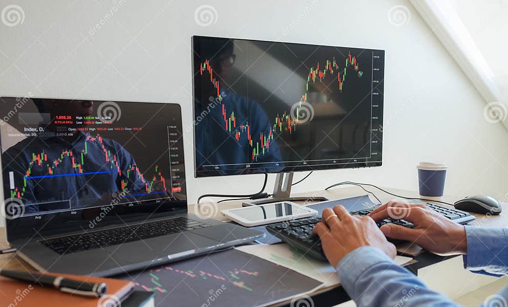 Trading on the Table is Working on a Computer Screen Full of Charts and ...