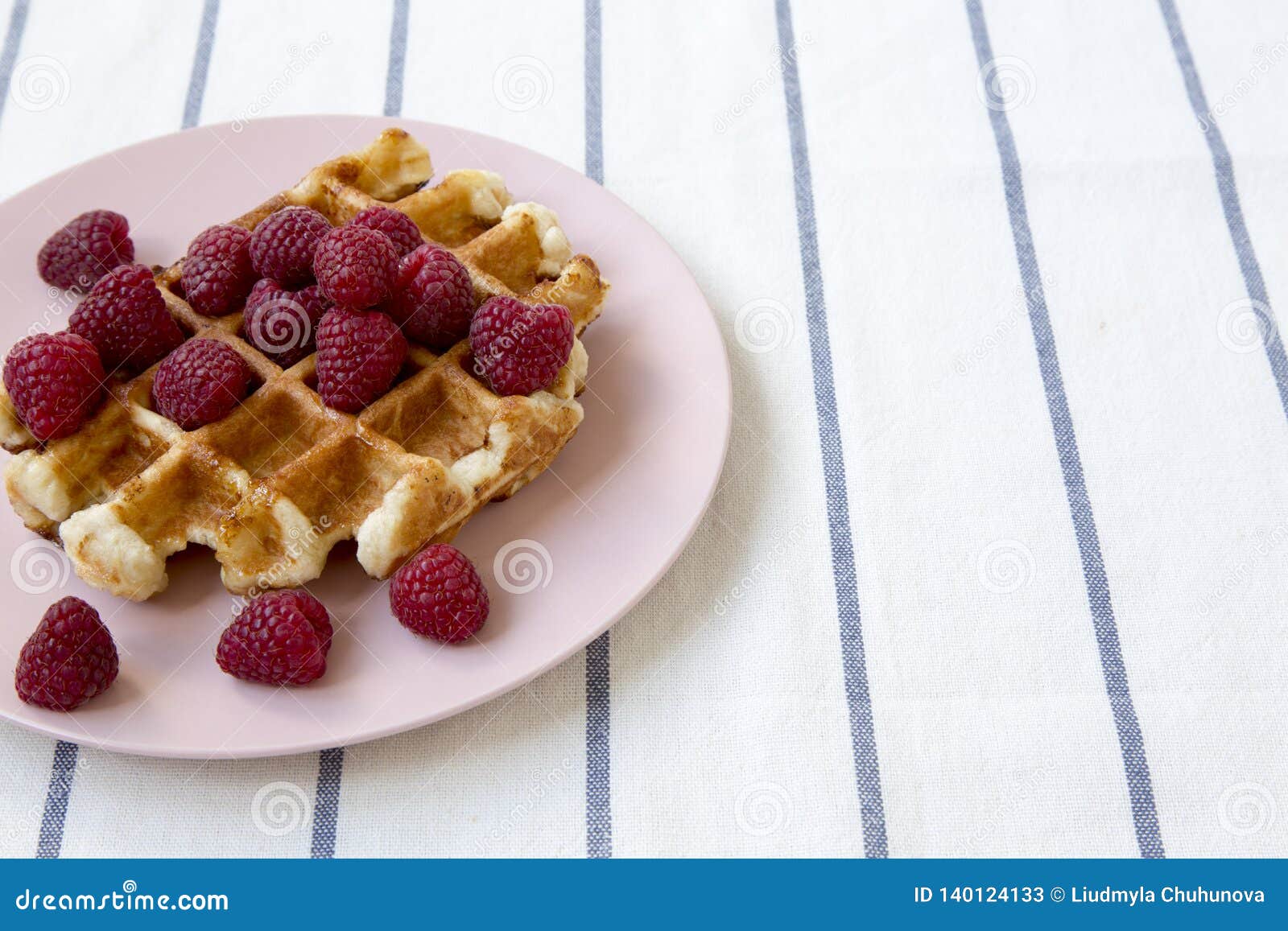Traditional Belgian Waffle with Raspberries on Pink Plate, Side View ...
