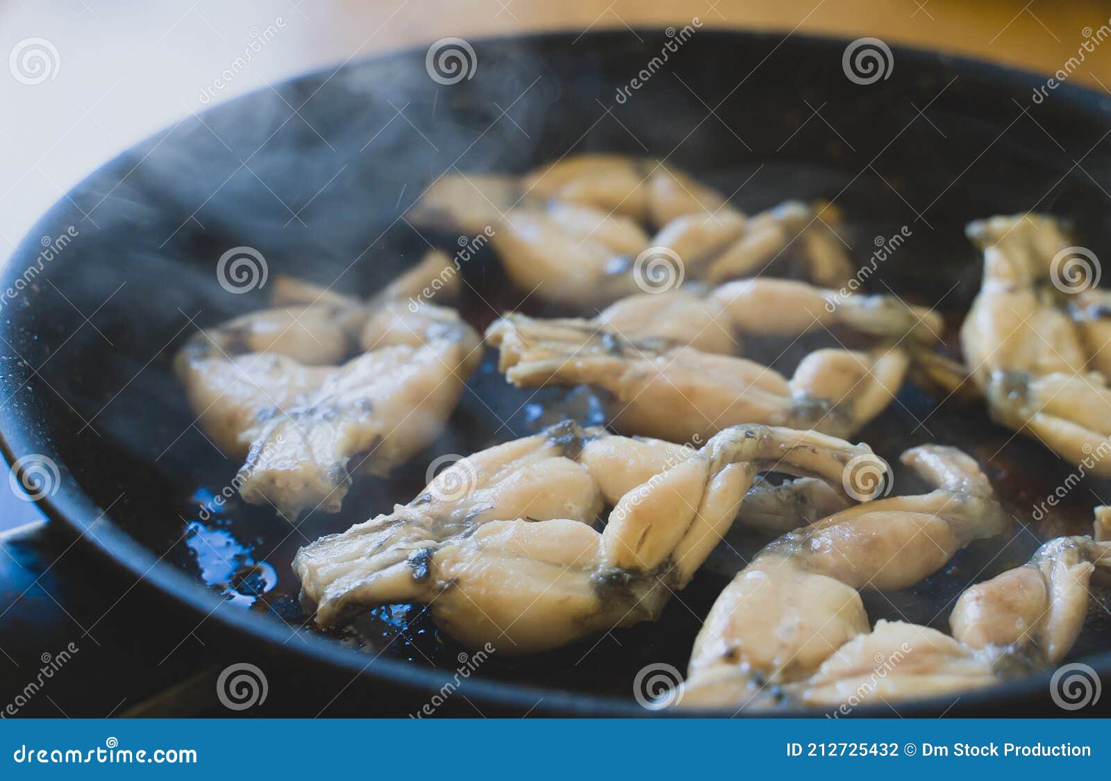 Fried frog legs on pan stock photo. Image of french - 212725432