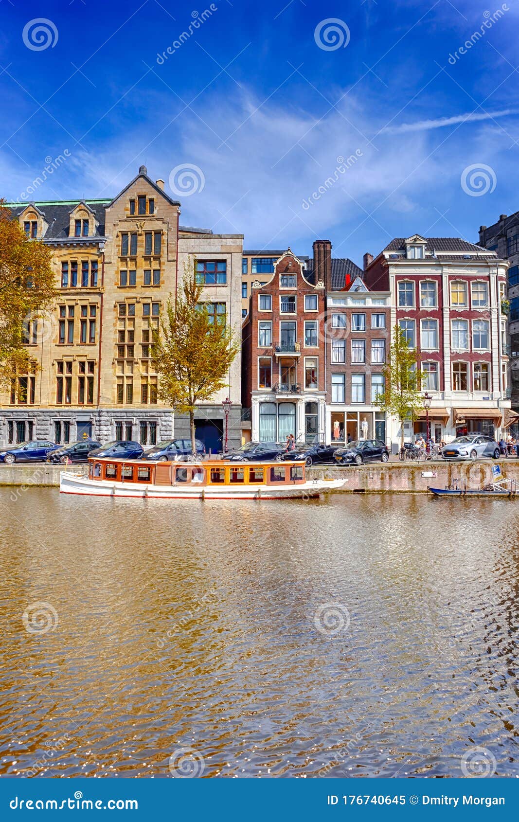 Traditional Dutch Cityscape of Amsterdam with Barge in the Foreground ...