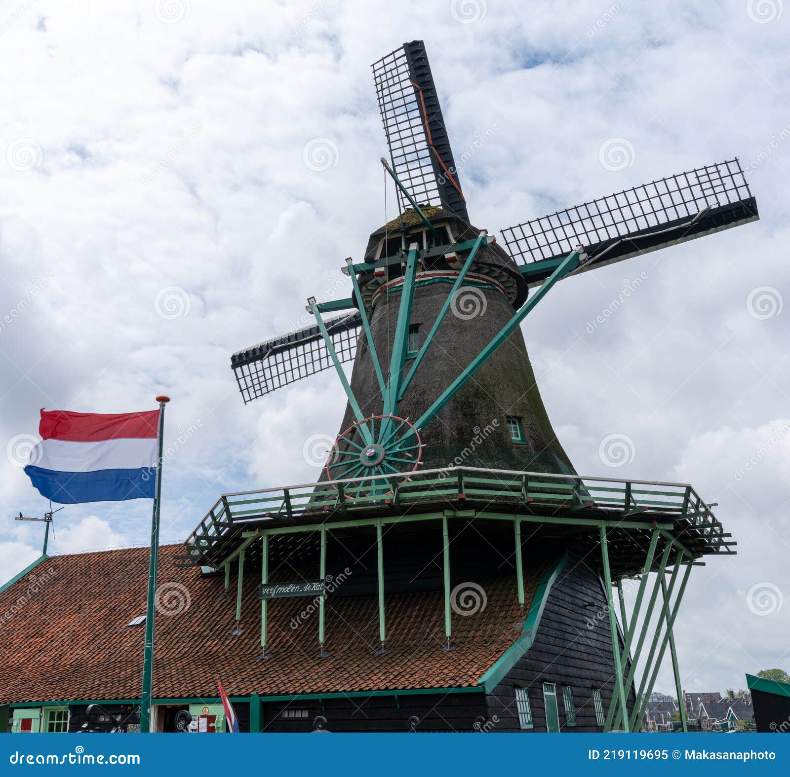 Traditional Dutch Windmill Under an Overcast Sky with the Flag of the ...