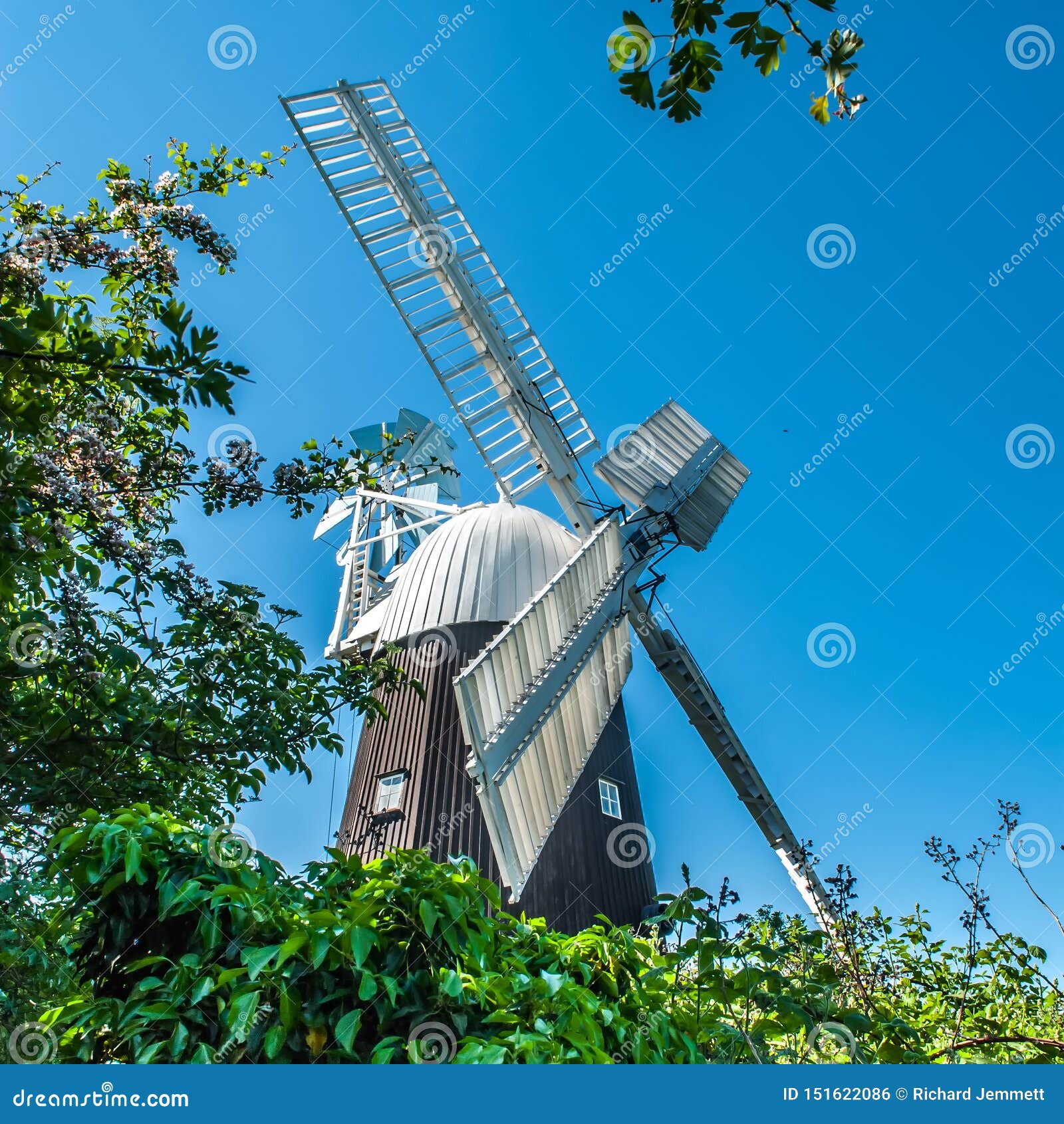 Traditional English Windmill Against Blue Sky Stock Photo - Image of ...