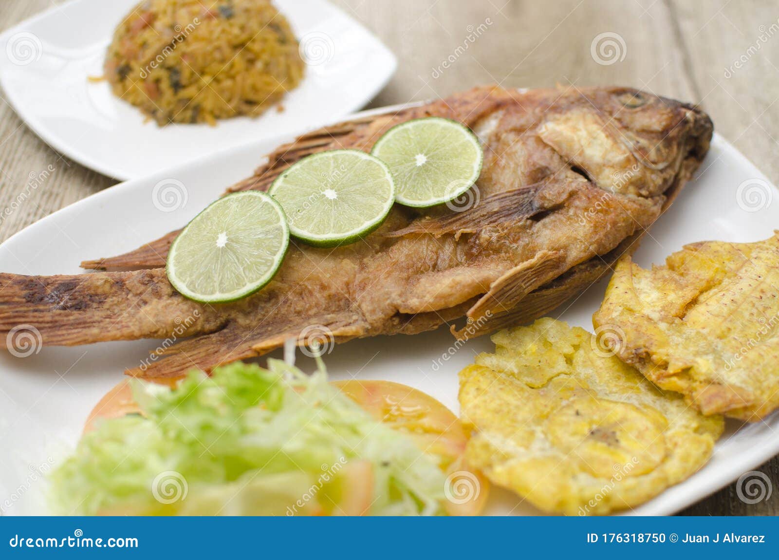 Traditional Fried Fish with Rice, Salad and Fried Plantain Stock Photo ...