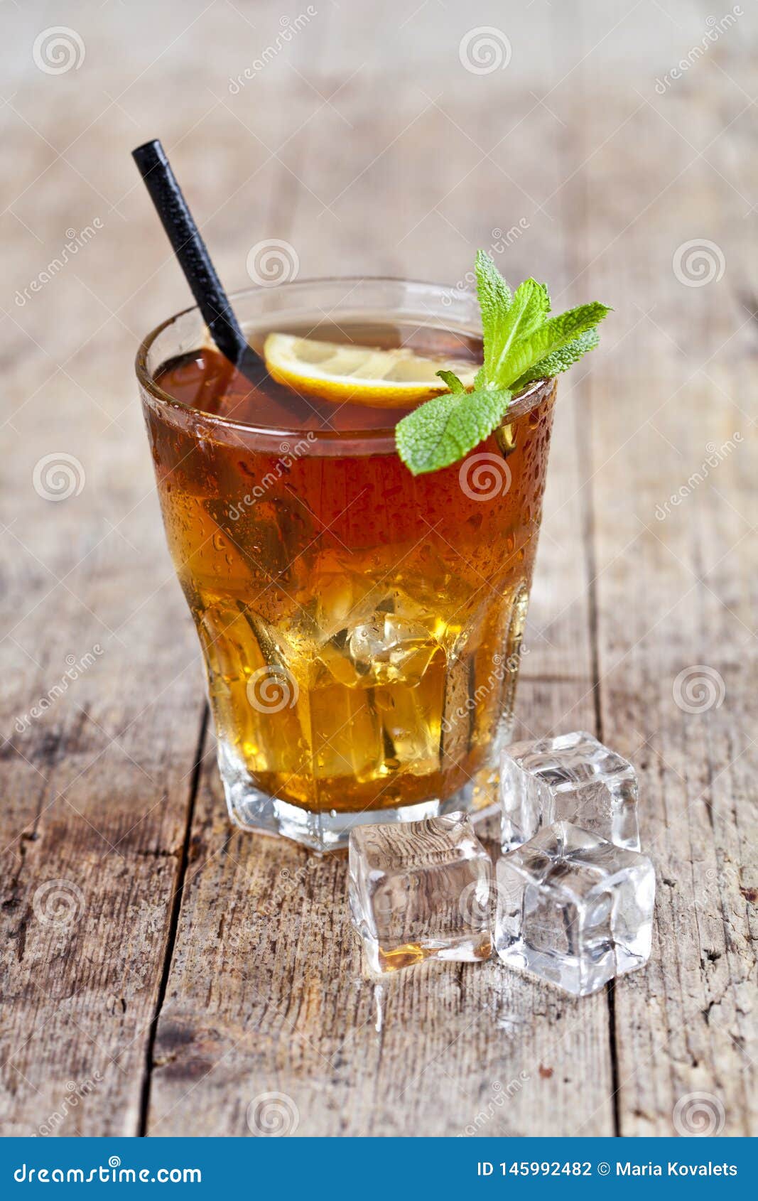 Traditional Iced Tea With Lemon Mint Leaves And Ice Cubes In Glass On