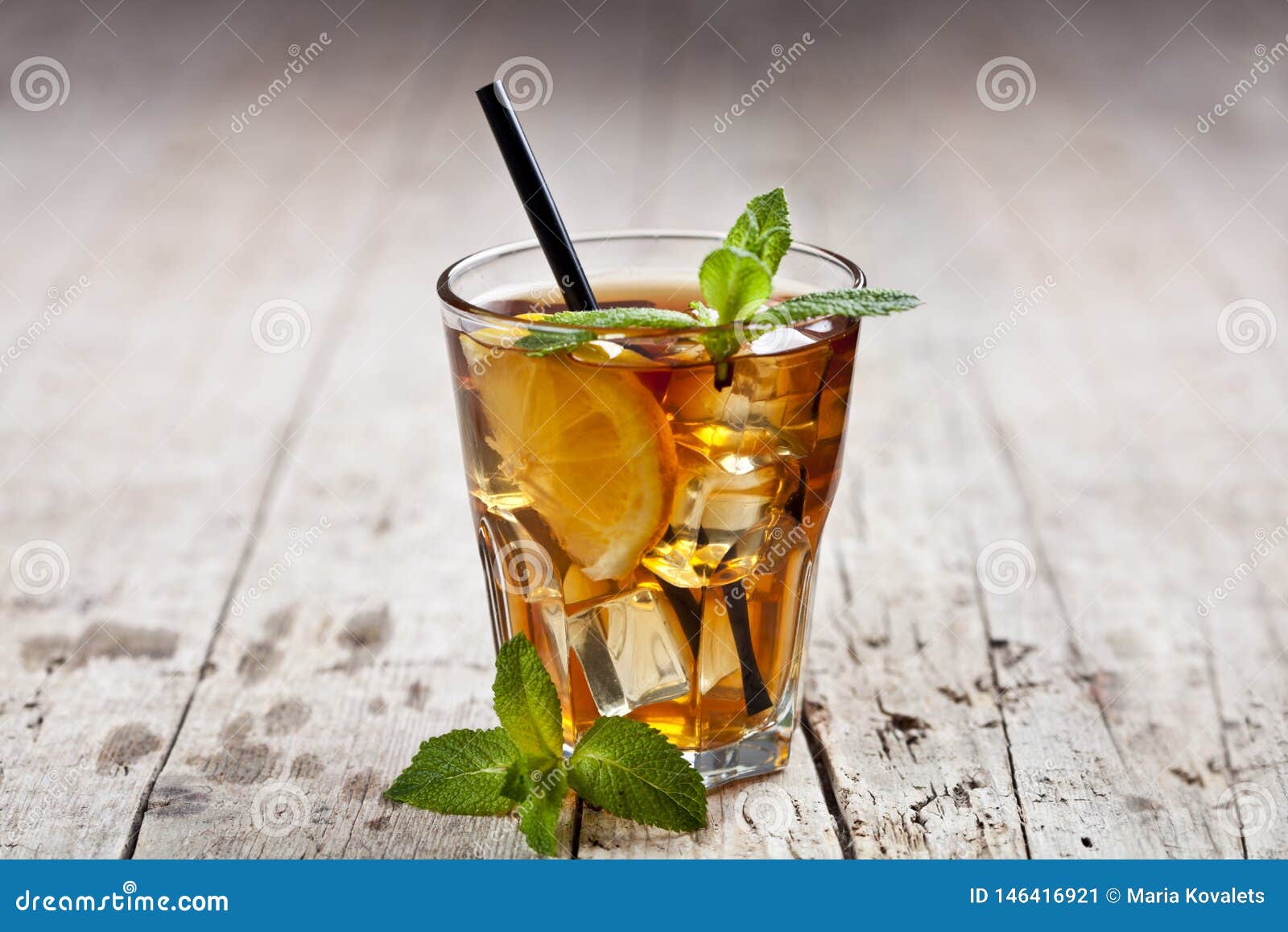 Traditional Iced Tea With Lemon Mint Leaves And Ice Cubes In Glass On