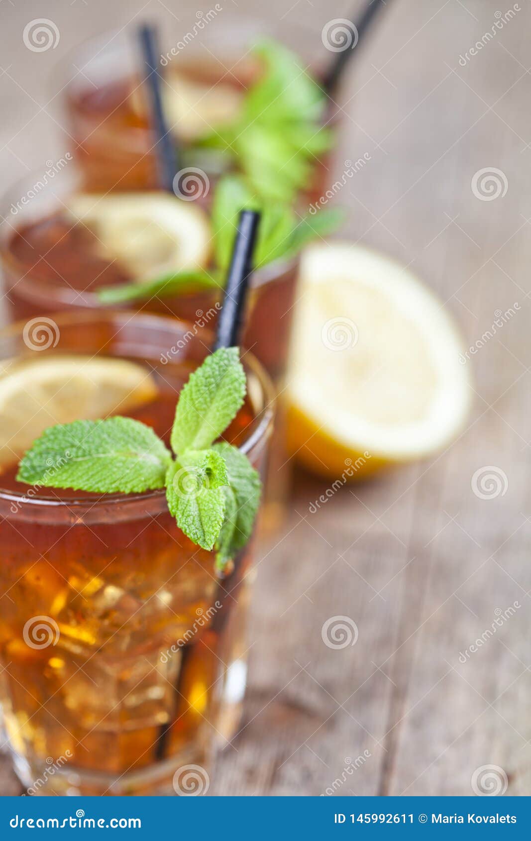 Traditional Iced Tea With Lemon Mint Leaves And Ice Cubes In Glasses
