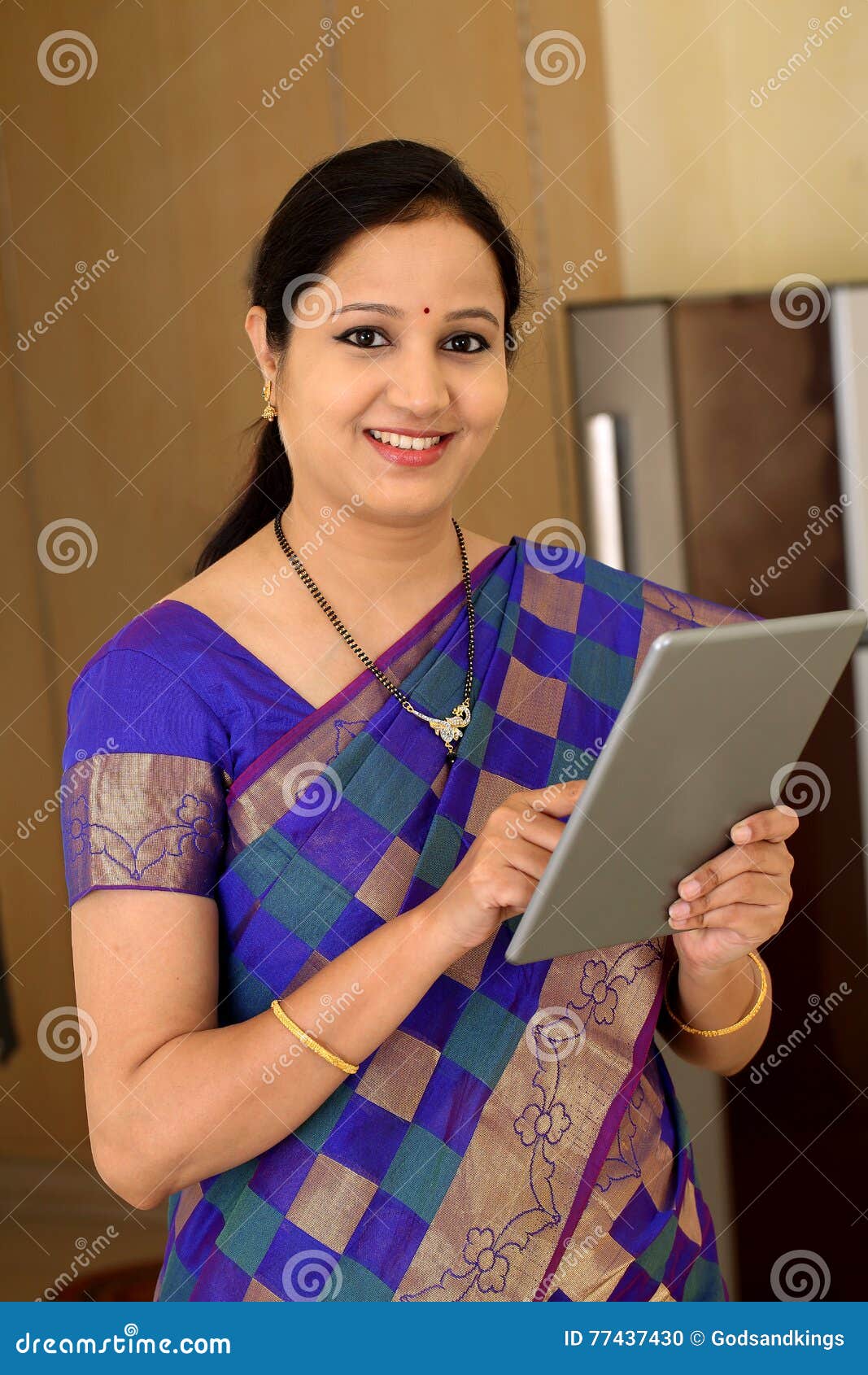Traditional Indian Woman Using a Tablet Computer Stock Photo - Image of ...