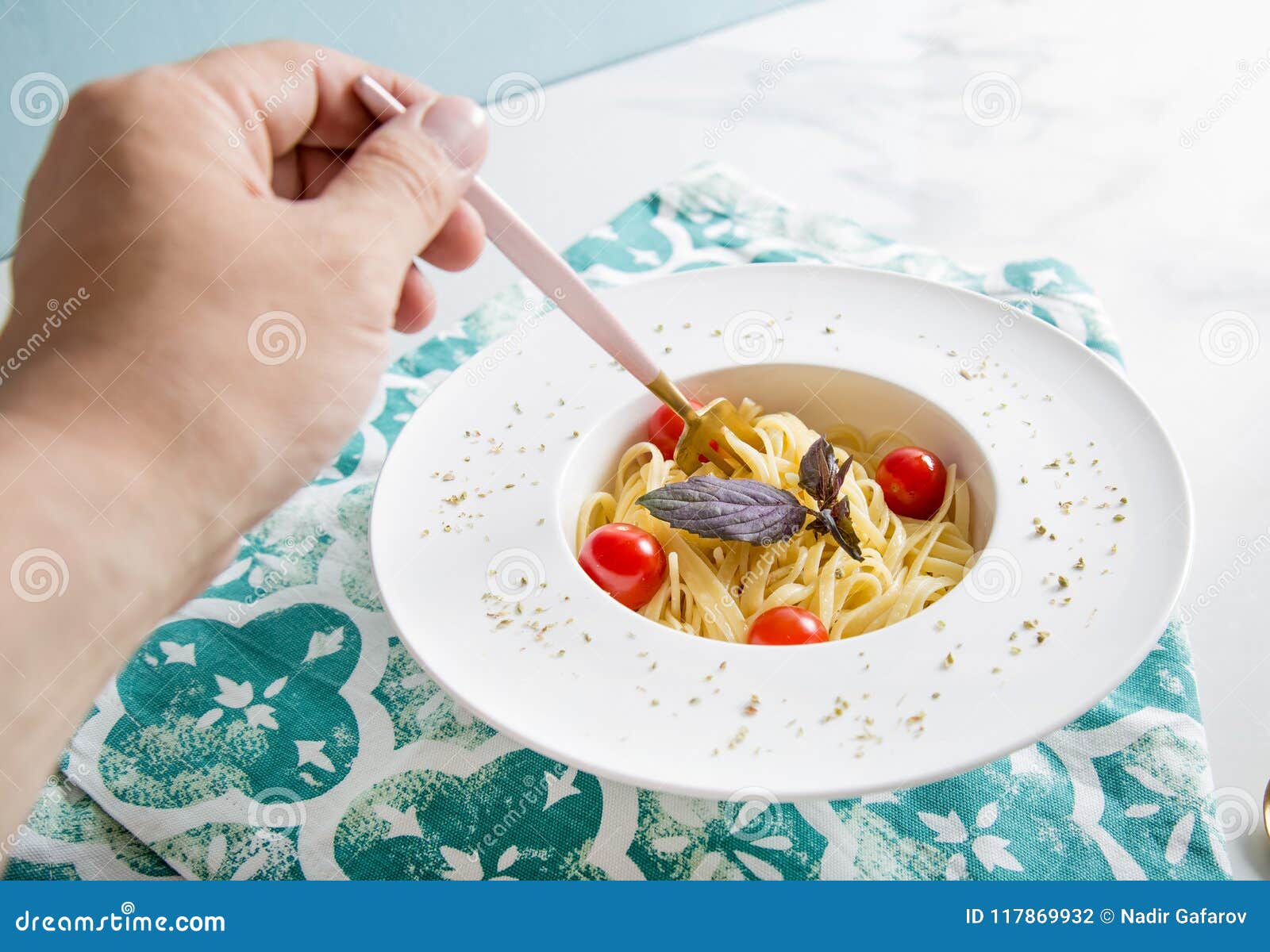 Traditional Italian Pasta with Tomatoes and Basil in Plate with Fork ...