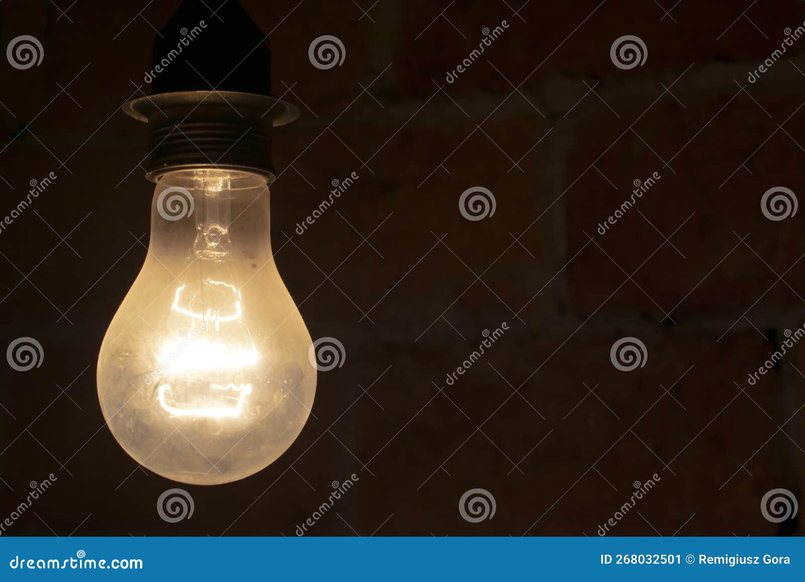 Traditional Light Bulb Glowing in a Dark Room Stock Image - Image of ...