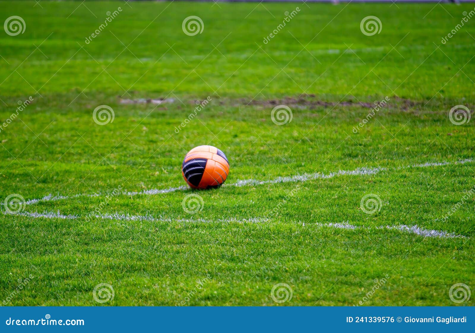 Traditional Orange Soccer Ball on Soccer Field Stock Photo - Image of ...