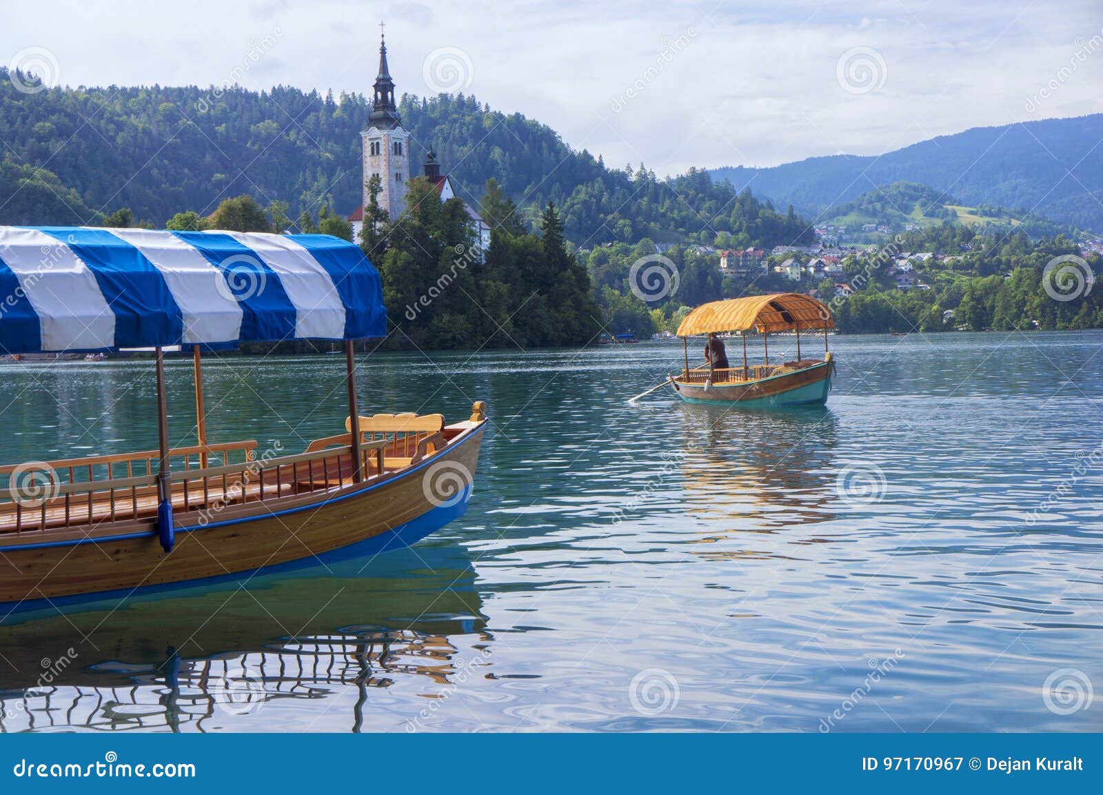 Traditional Pletna Boat Waiting For Tourists On Lake Bled, With The ...