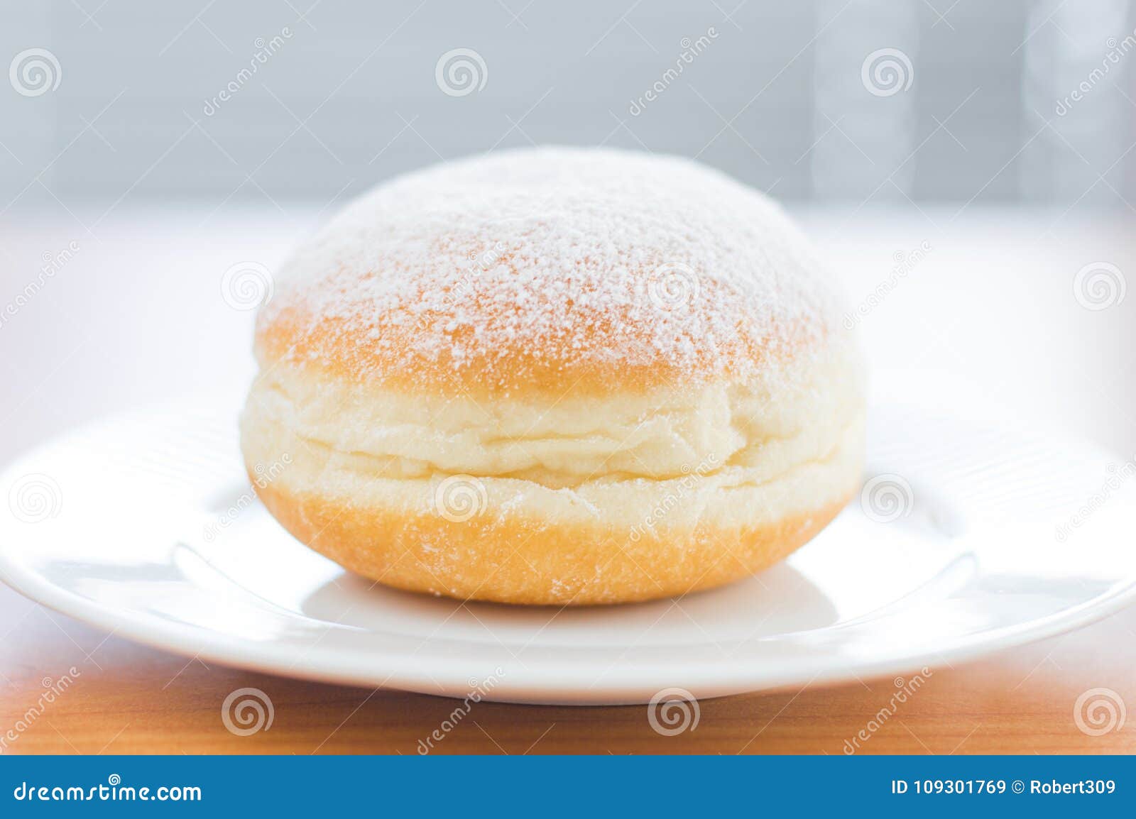 Traditional Polish Paczek with Powdered Sugar on White Plate Stock ...