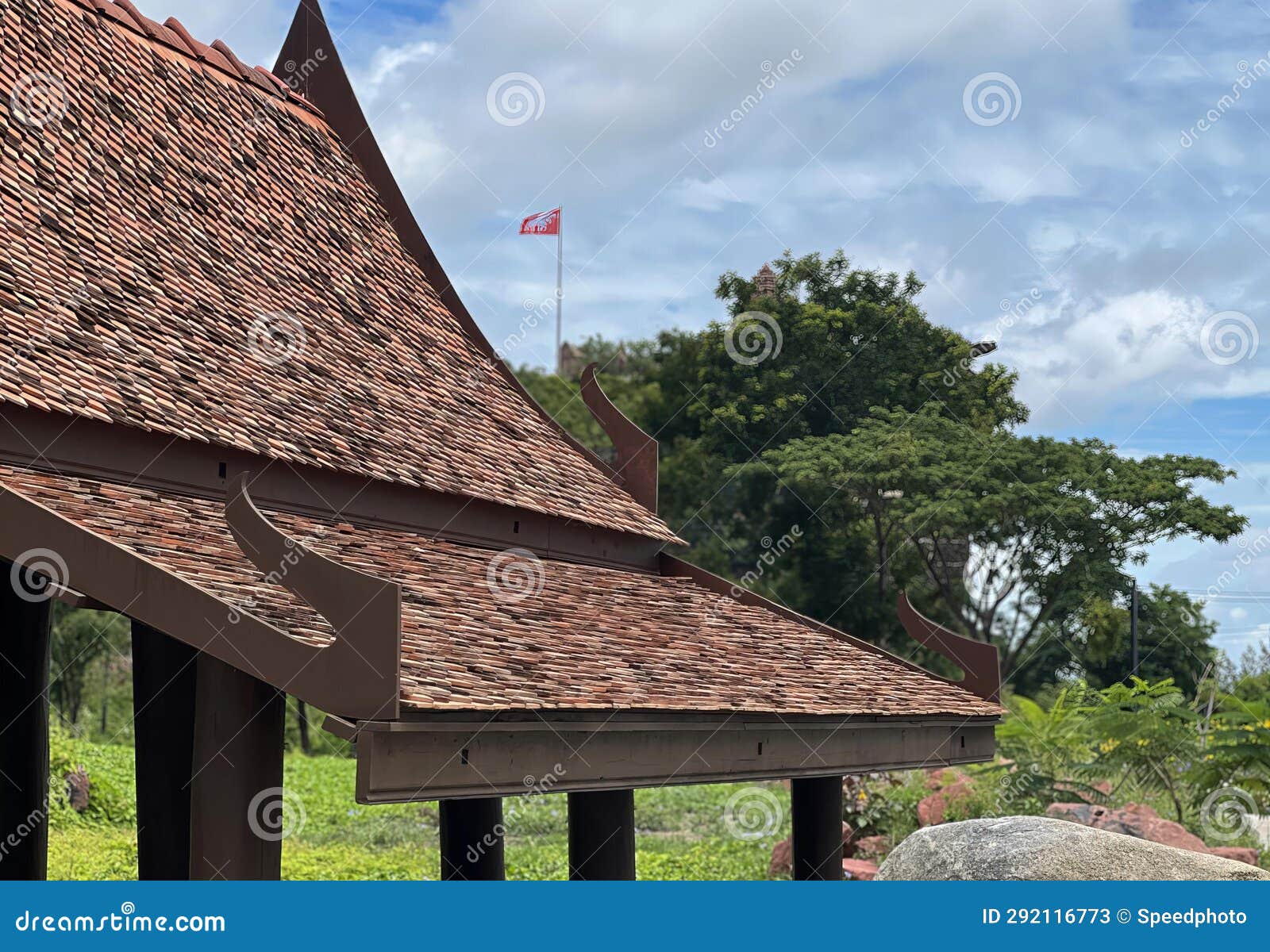 A Traditional Roof with a Flag on Top Stock Image - Image of emblem ...