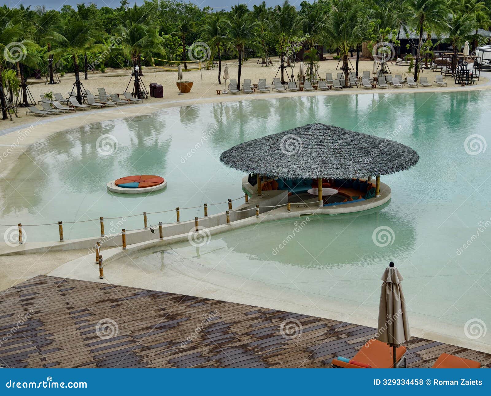 A Traditional Thatched Hut is Located within a Swimming Pool Stock ...