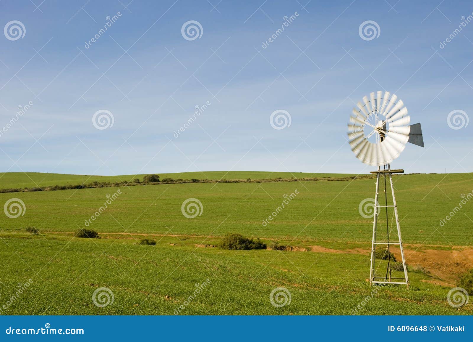 Traditional Windmill in a Green Pasture Stock Photo - Image of steel ...