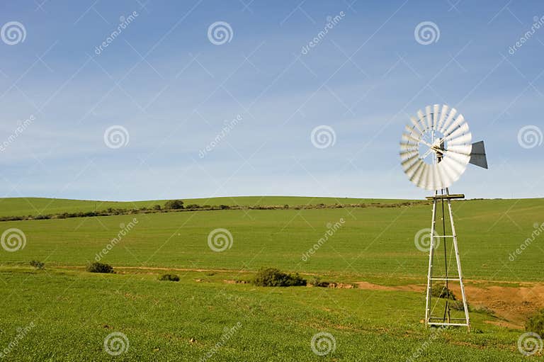 Traditional Windmill in a Green Pasture Stock Photo - Image of steel ...