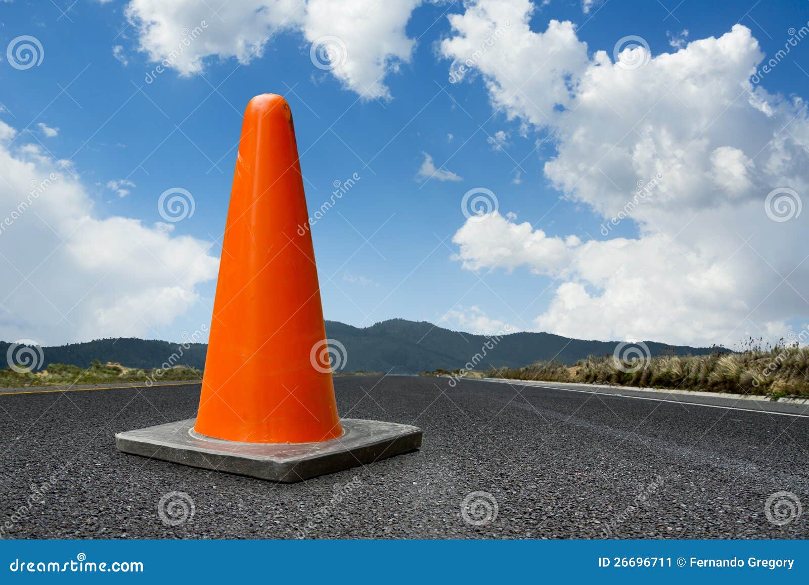 Traffic Cone on a Road with a Bright Blue Sky Stock Image - Image of ...
