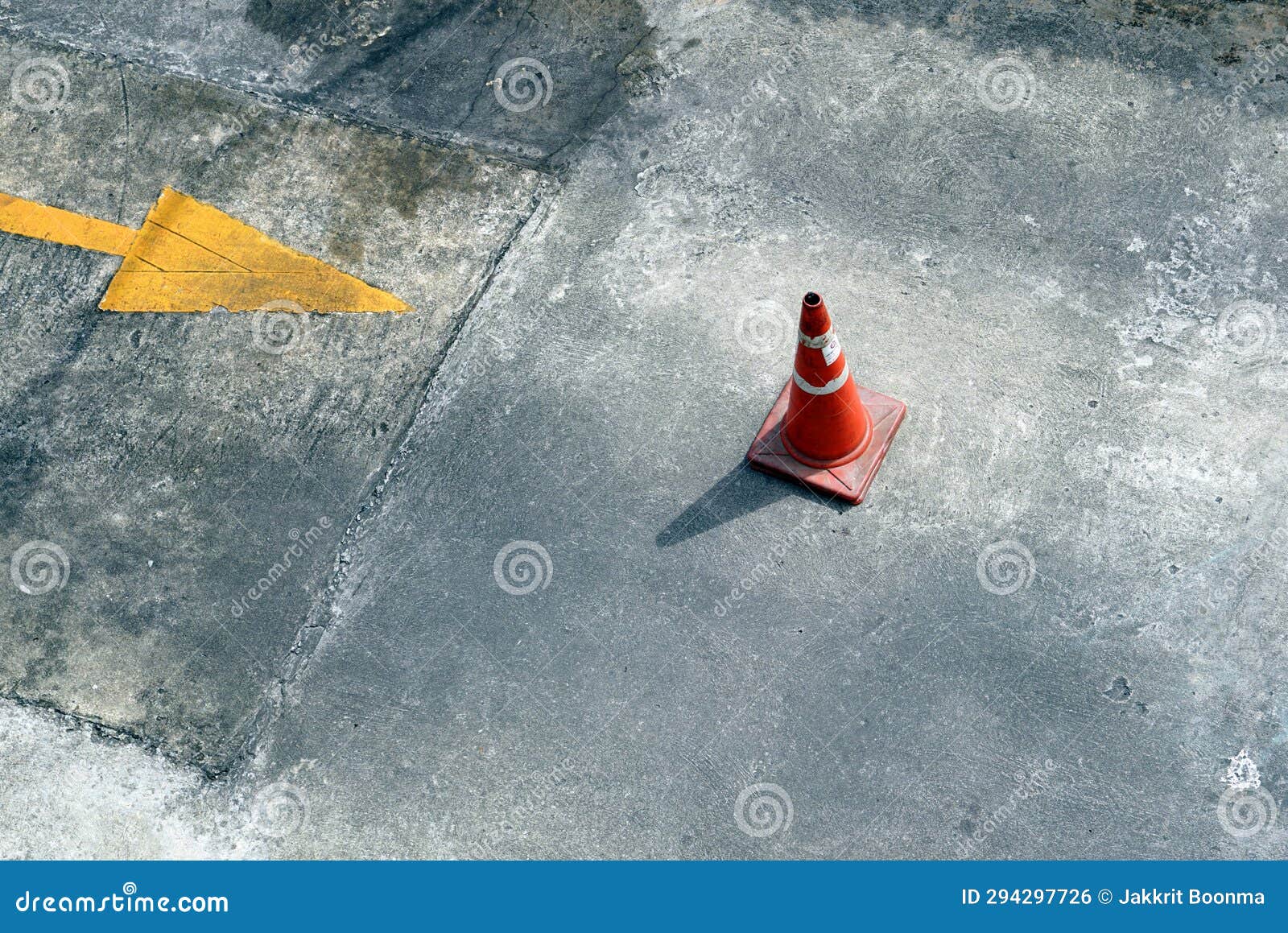 Traffic Cone on the Road with Yellow Arrow on the Ground Stock Photo ...