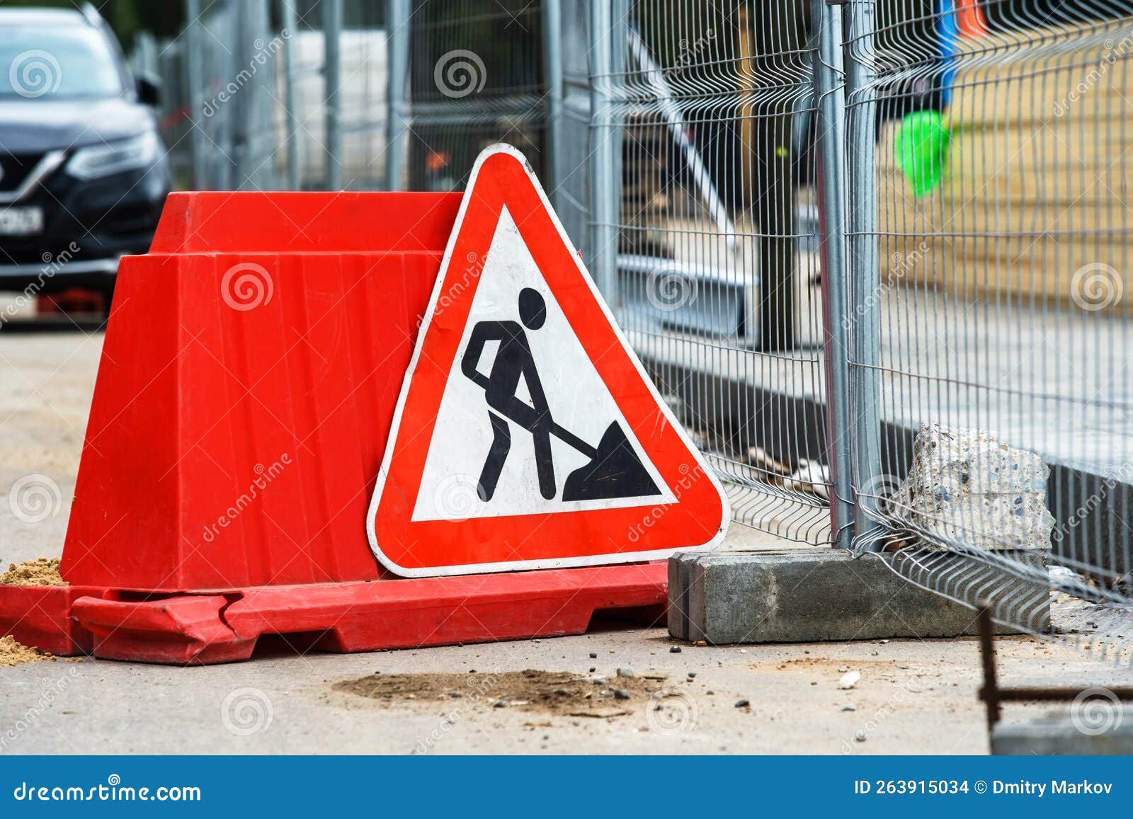 Traffic Fence and a Triangular Sign with Information about Construction ...