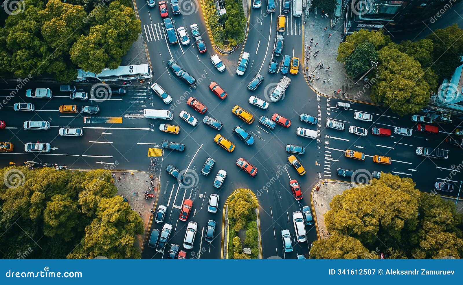 Traffic Flows Steadily through City Intersections Surrounded by Trees ...