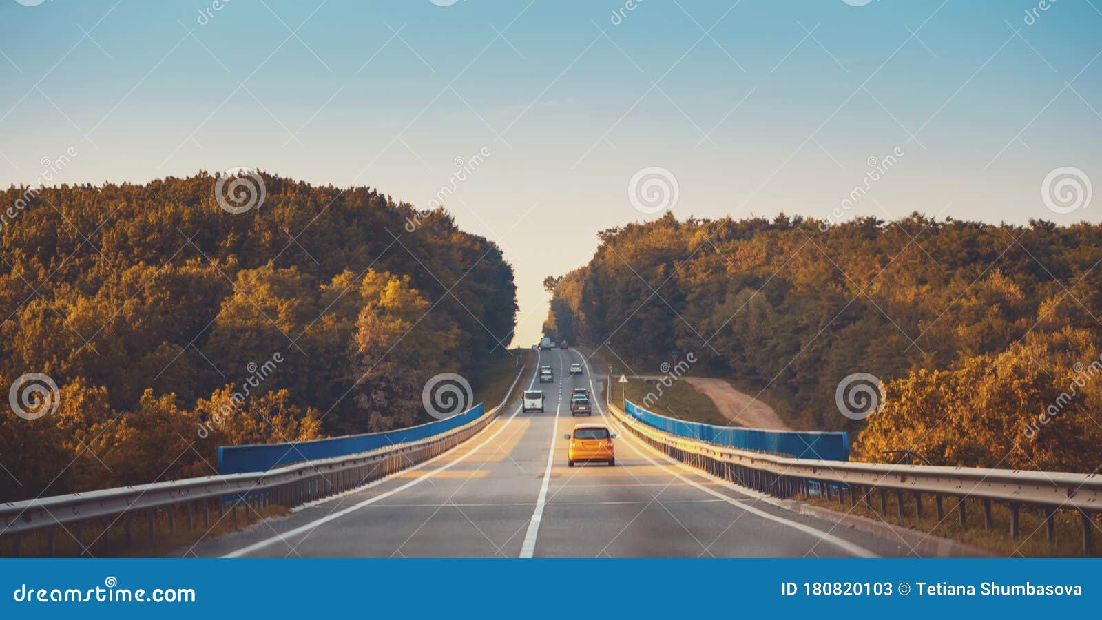 Traffic in High Speed on a Highway through Rural Landscape on Sunset ...