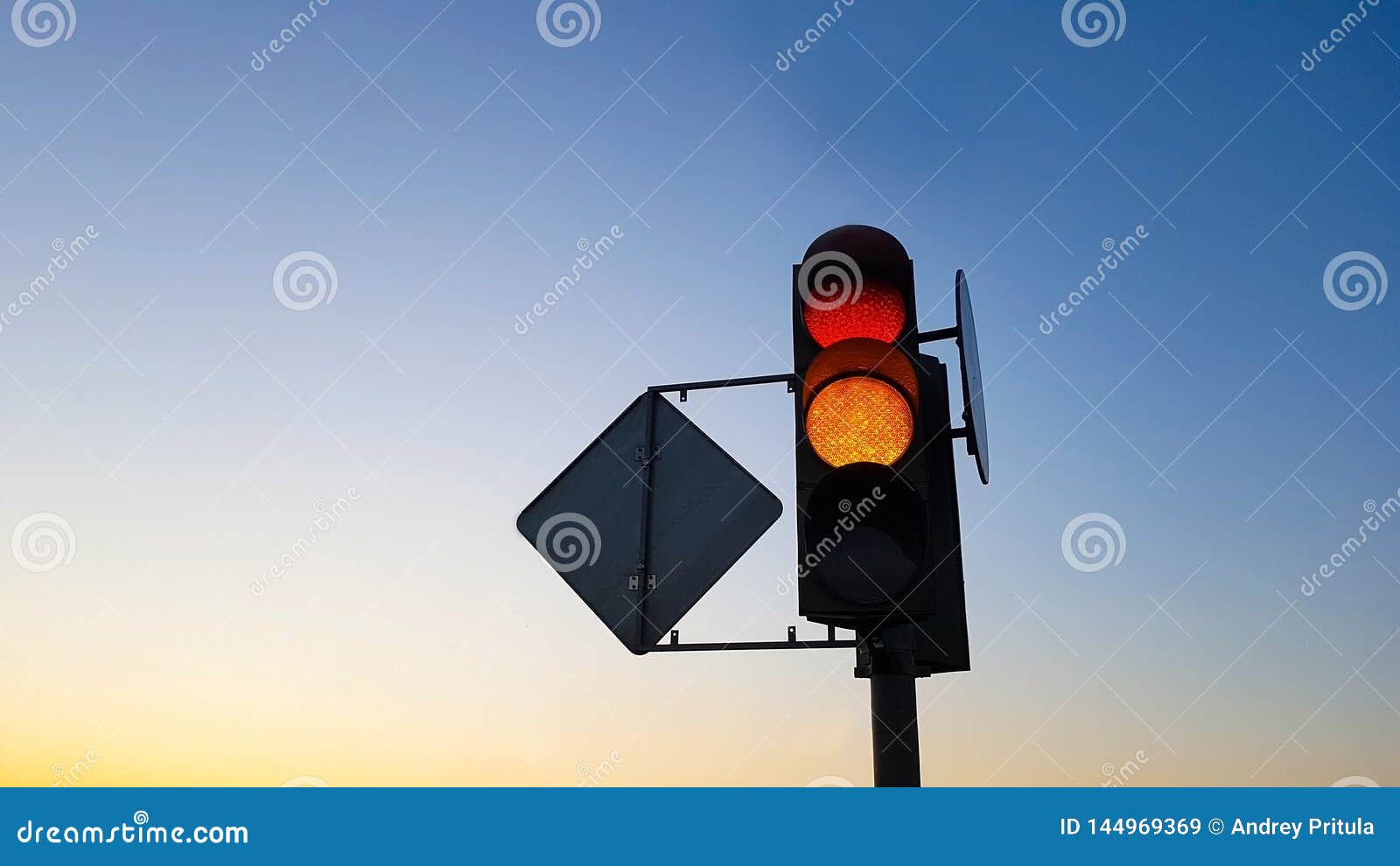 Traffic Light with Red and Yellow Signals on Blue Sky Background Stock ...