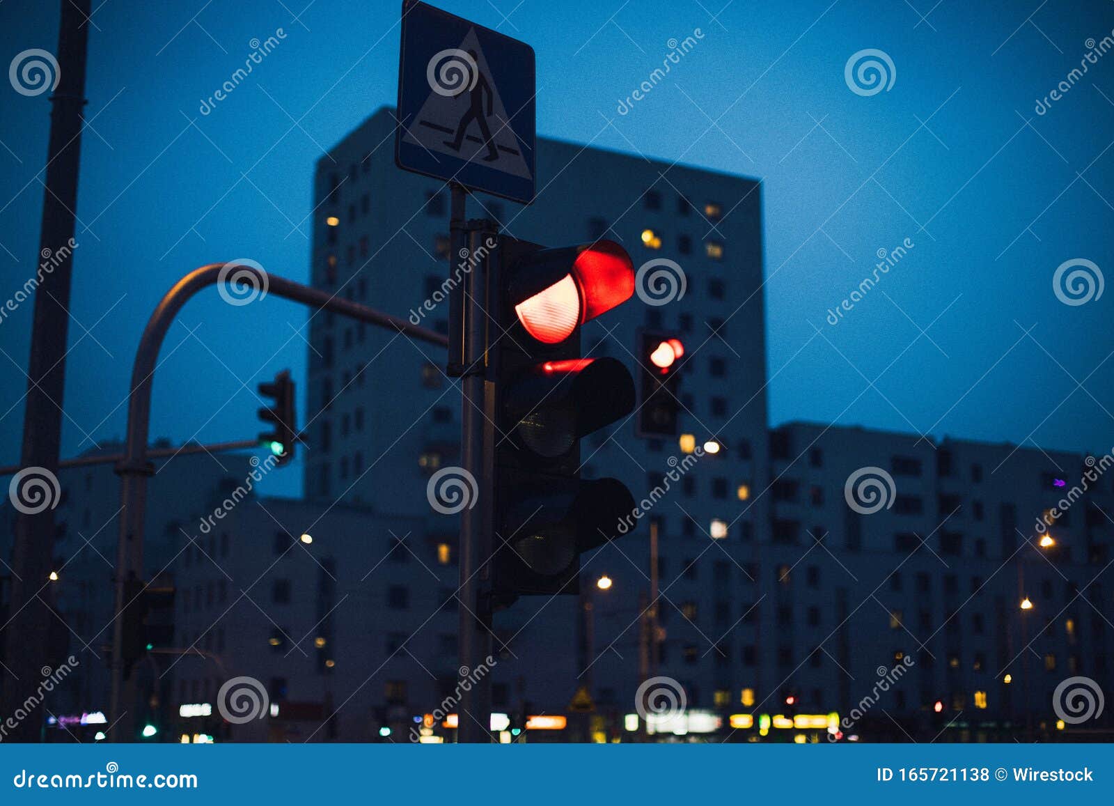 Traffic Light and Street Sign with Tall Building in the Background ...