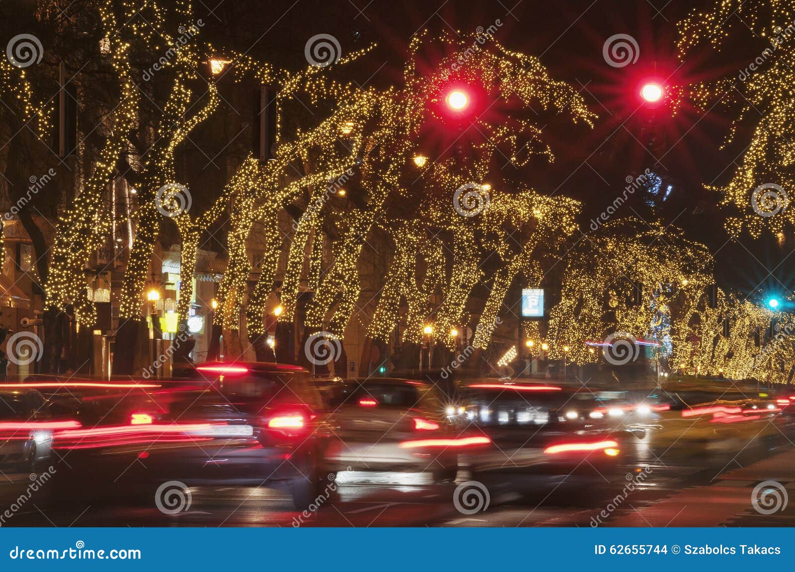Traffic at Night on Light String Decorated Street Stock Photo - Image ...