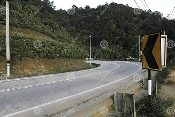Traffic Road Sign Warning a Sharp Bend in Front on an Empty Street ...