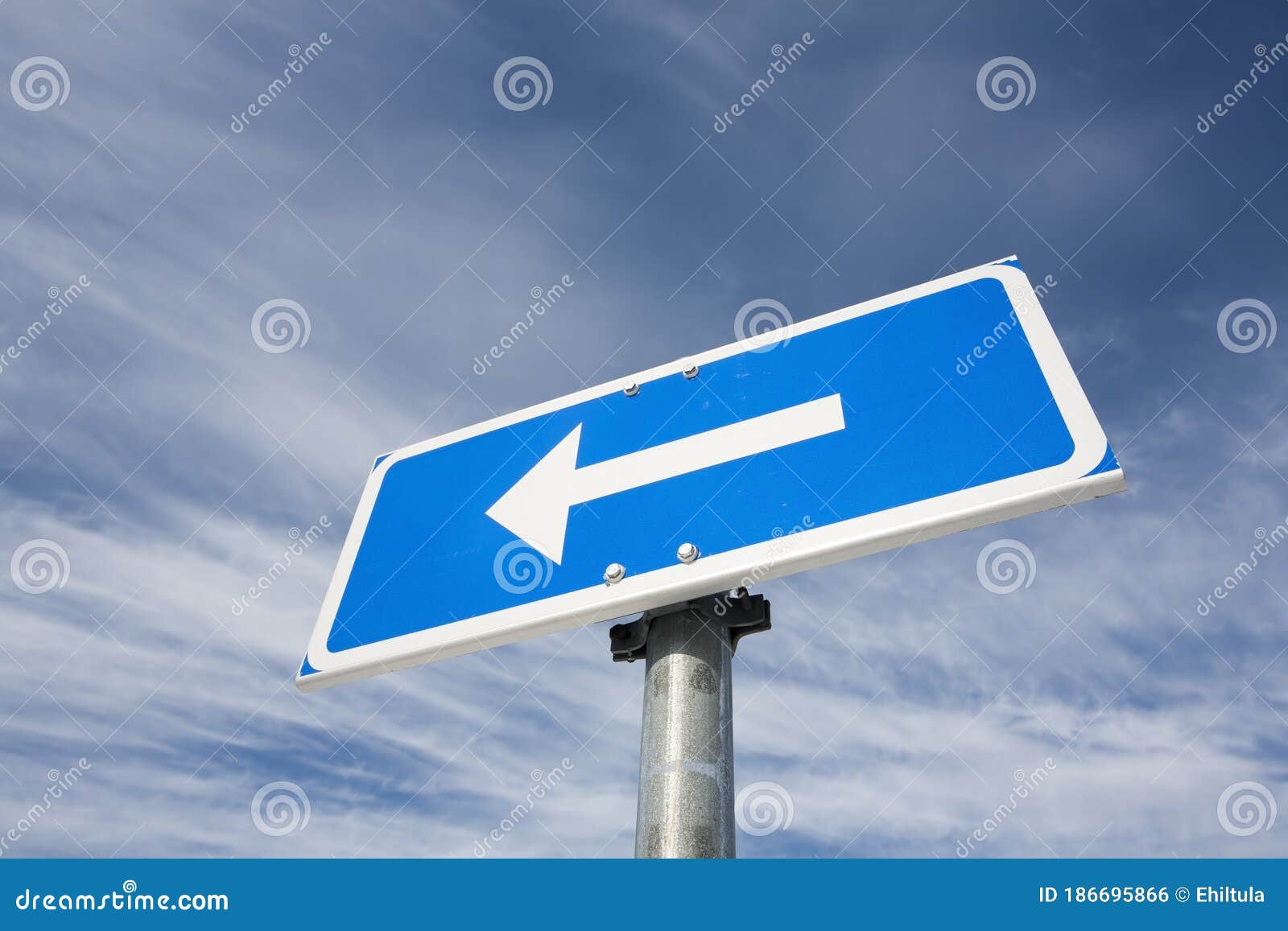 Traffic Sign Arrow Pointing Left Against Sky Stock Photo - Image of ...
