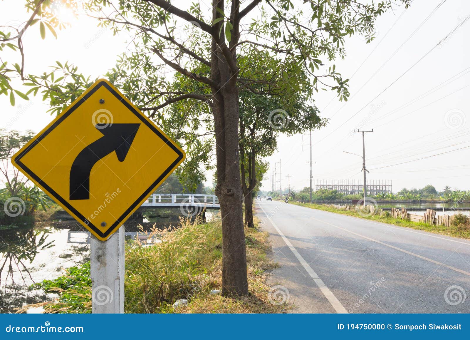 A Traffic Sign Shows a Curved Path beside the Road. on the Edge of the ...