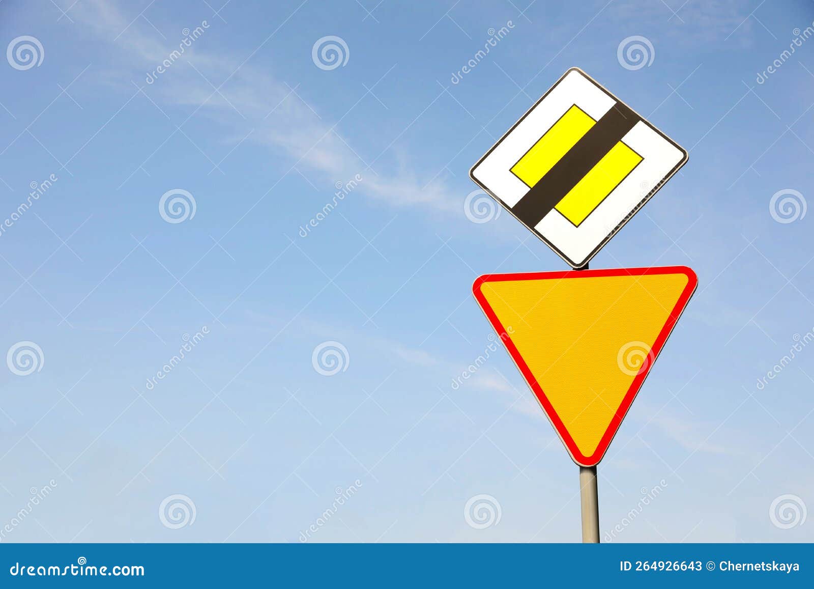 Traffic Signs End of Priority Road and Yield Against Blue Sky, Closeup ...