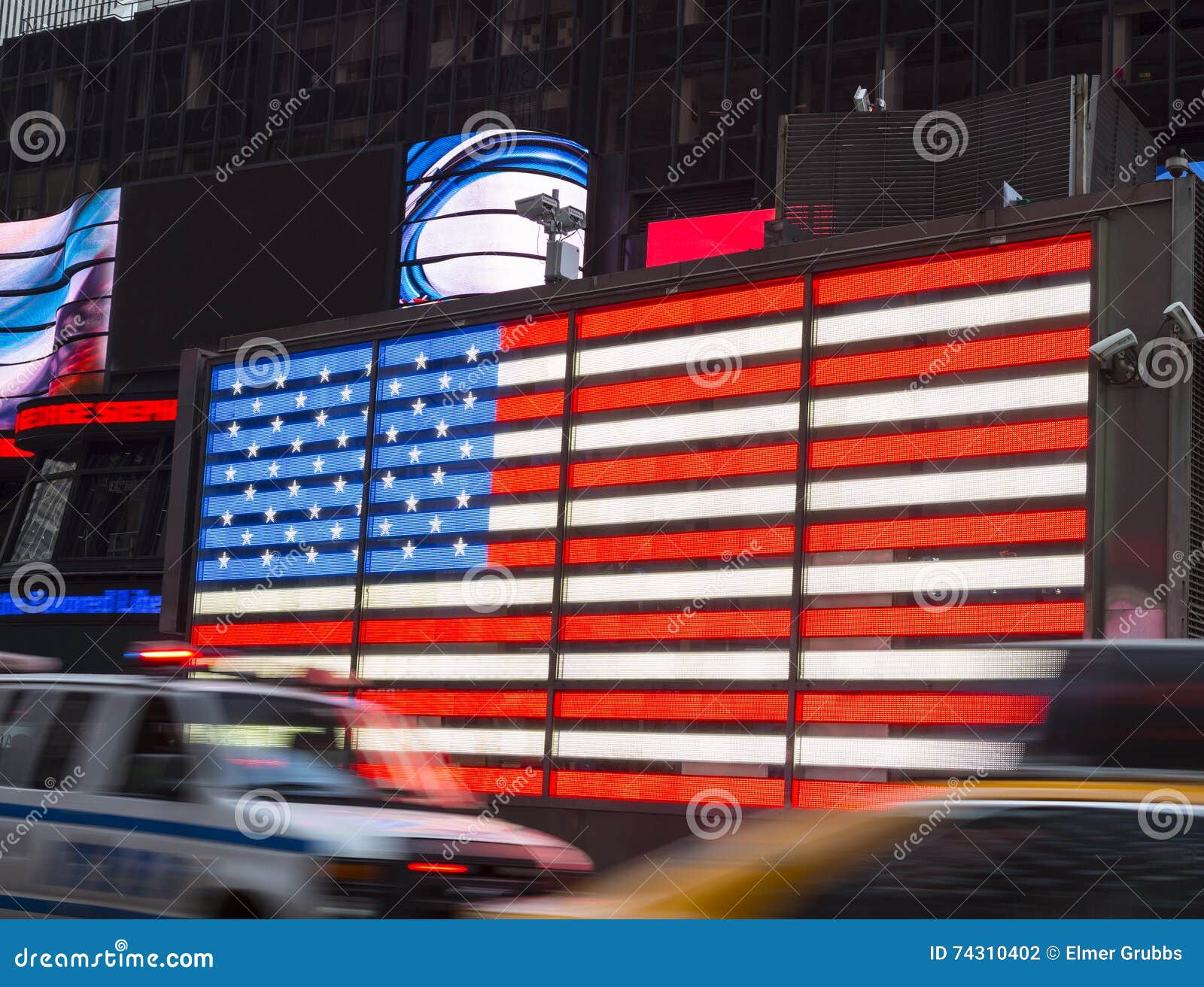 Traffic in Times Square in Front of American Flag Stock Photo - Image ...