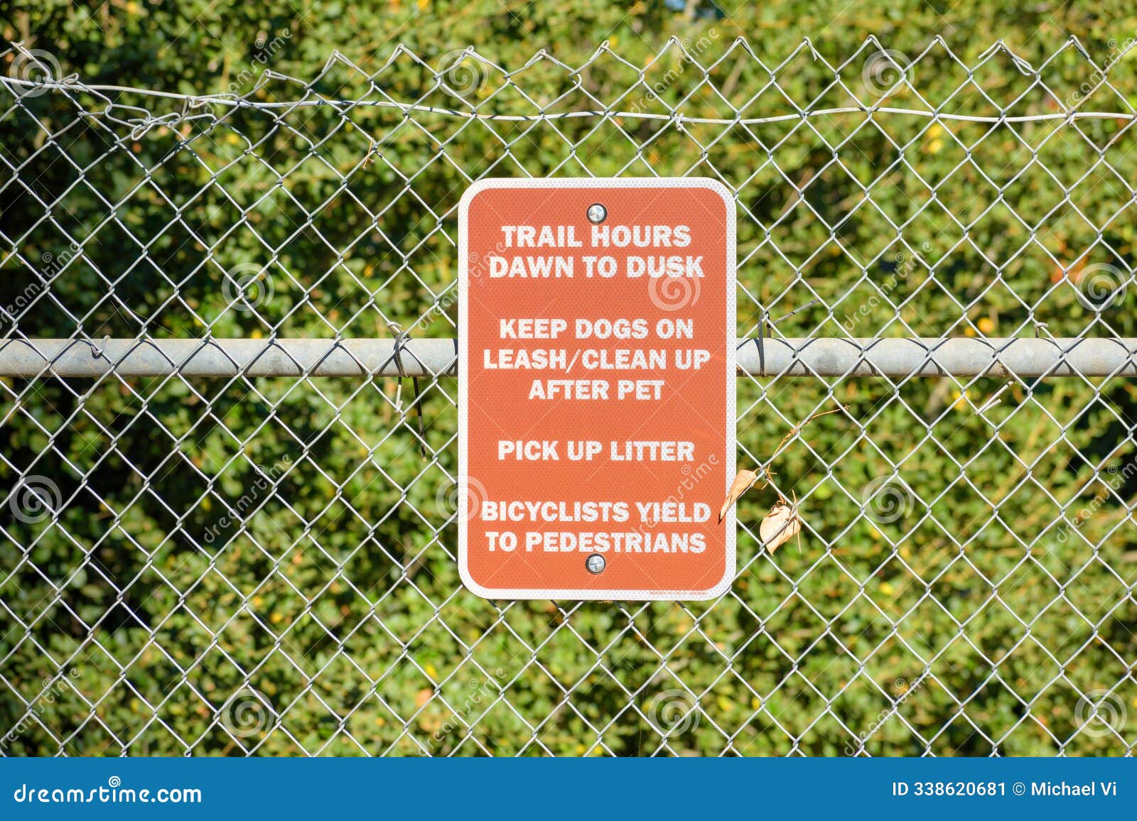A Trail Information Sign Hangs on a Chain-link Fence, Outlining ...