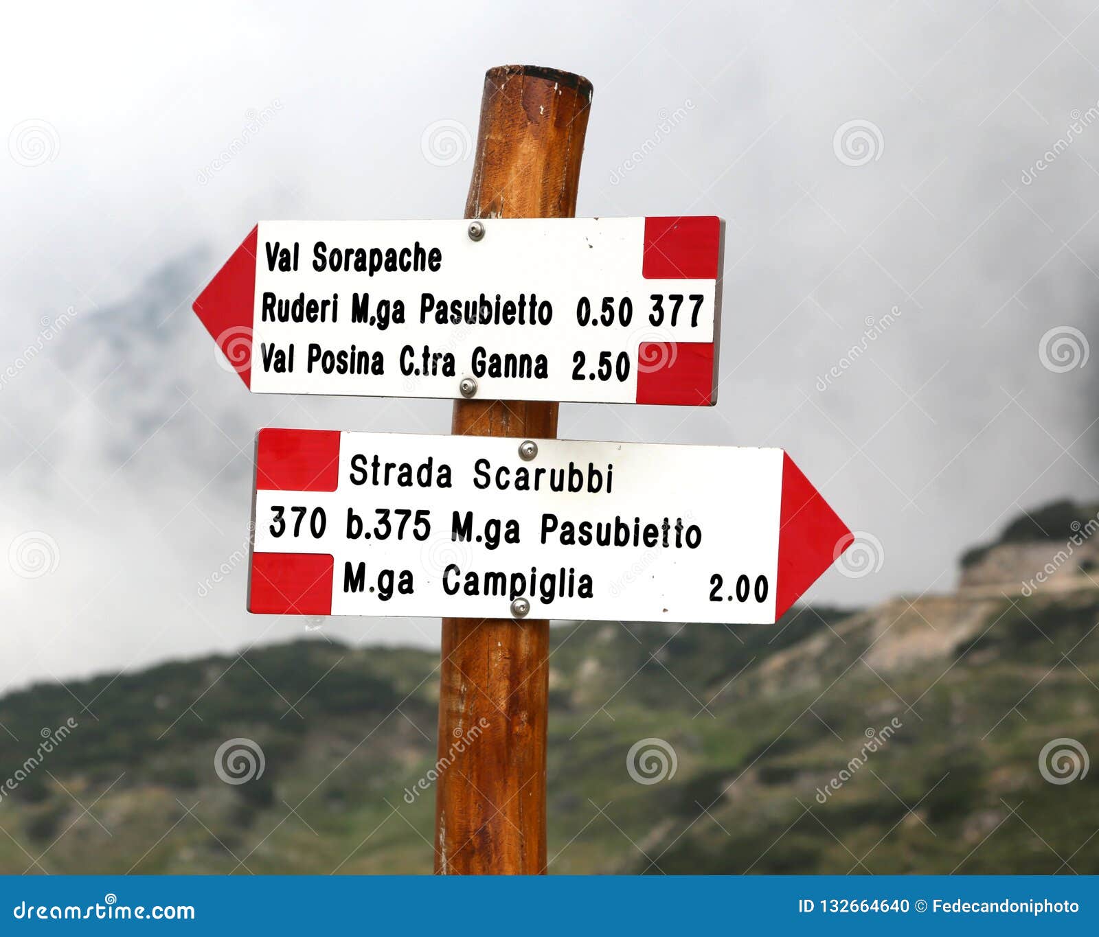 Trail Marker with Text of Italian Location in Mountains Stock Photo ...