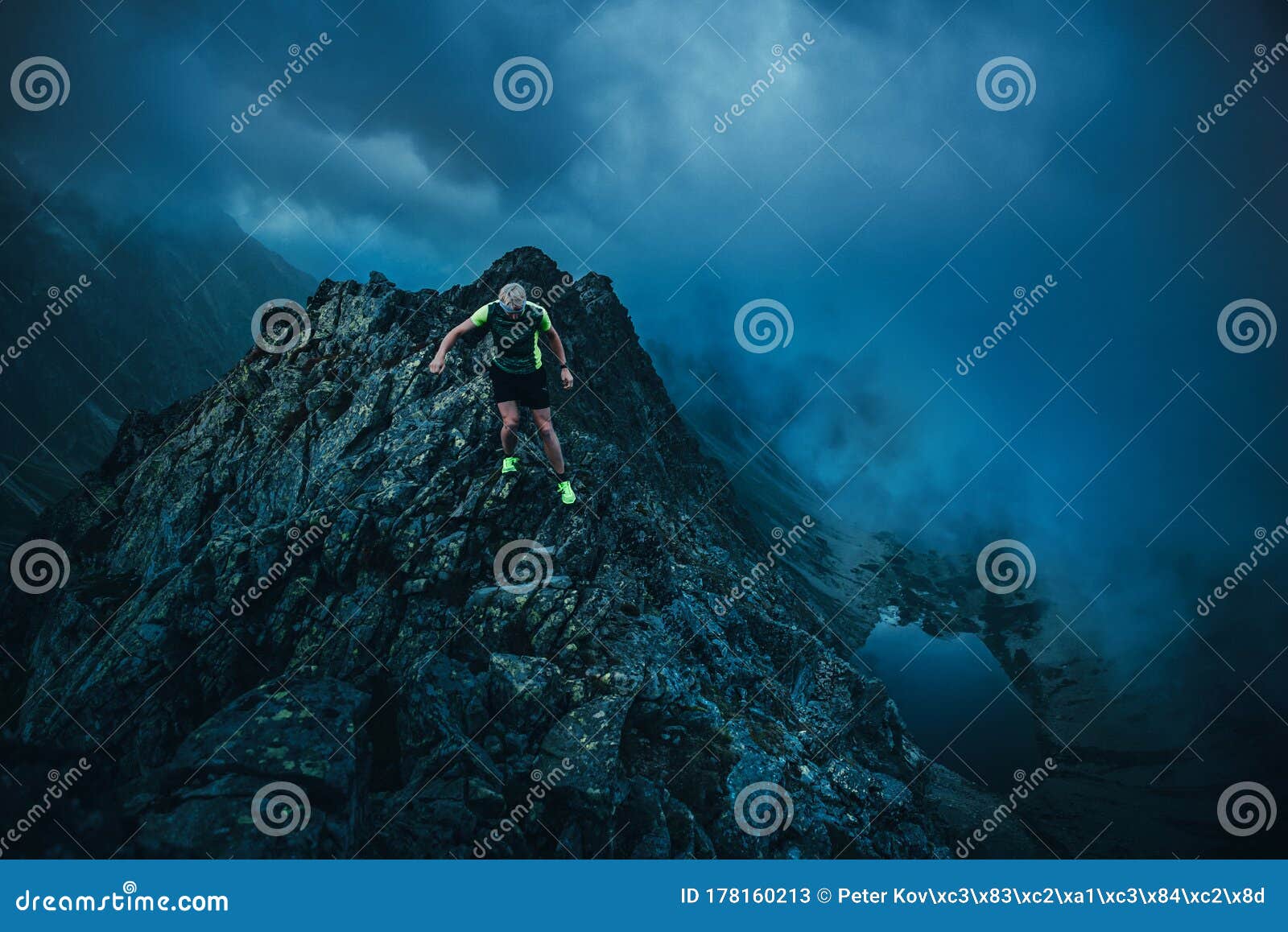 Trail Runner in Dark Evening Mountains, Rocks. Running in Storm Stock ...