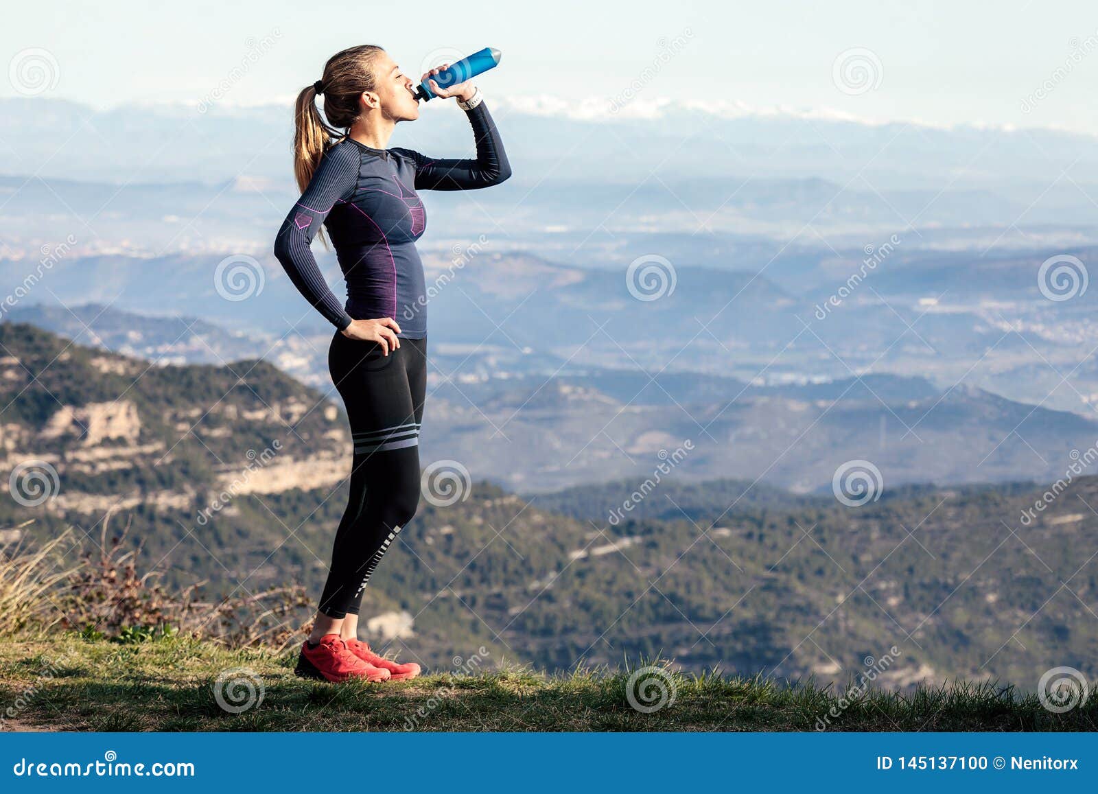 Trail Runner Drinking Water while Looking Landscape from Mountain Peak ...