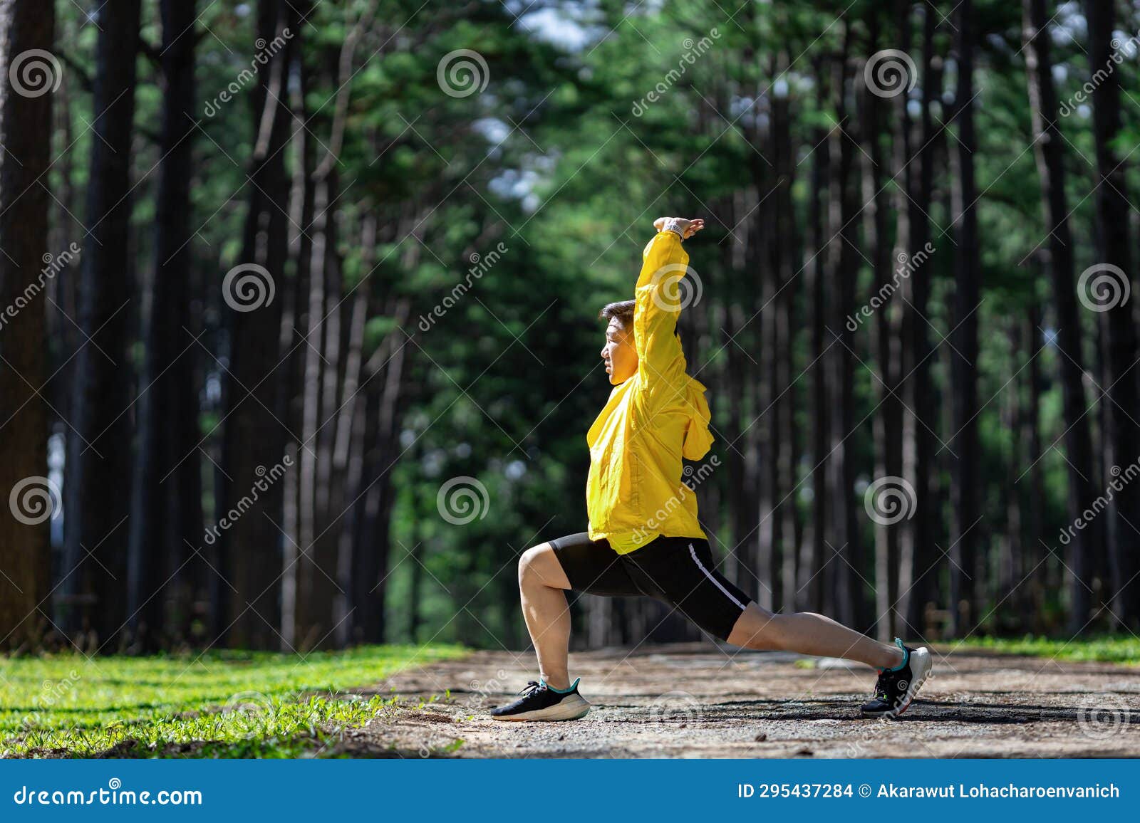 Trail Runner is Stretching for Warm Up Outdoor in the Pine Forest Dirt ...