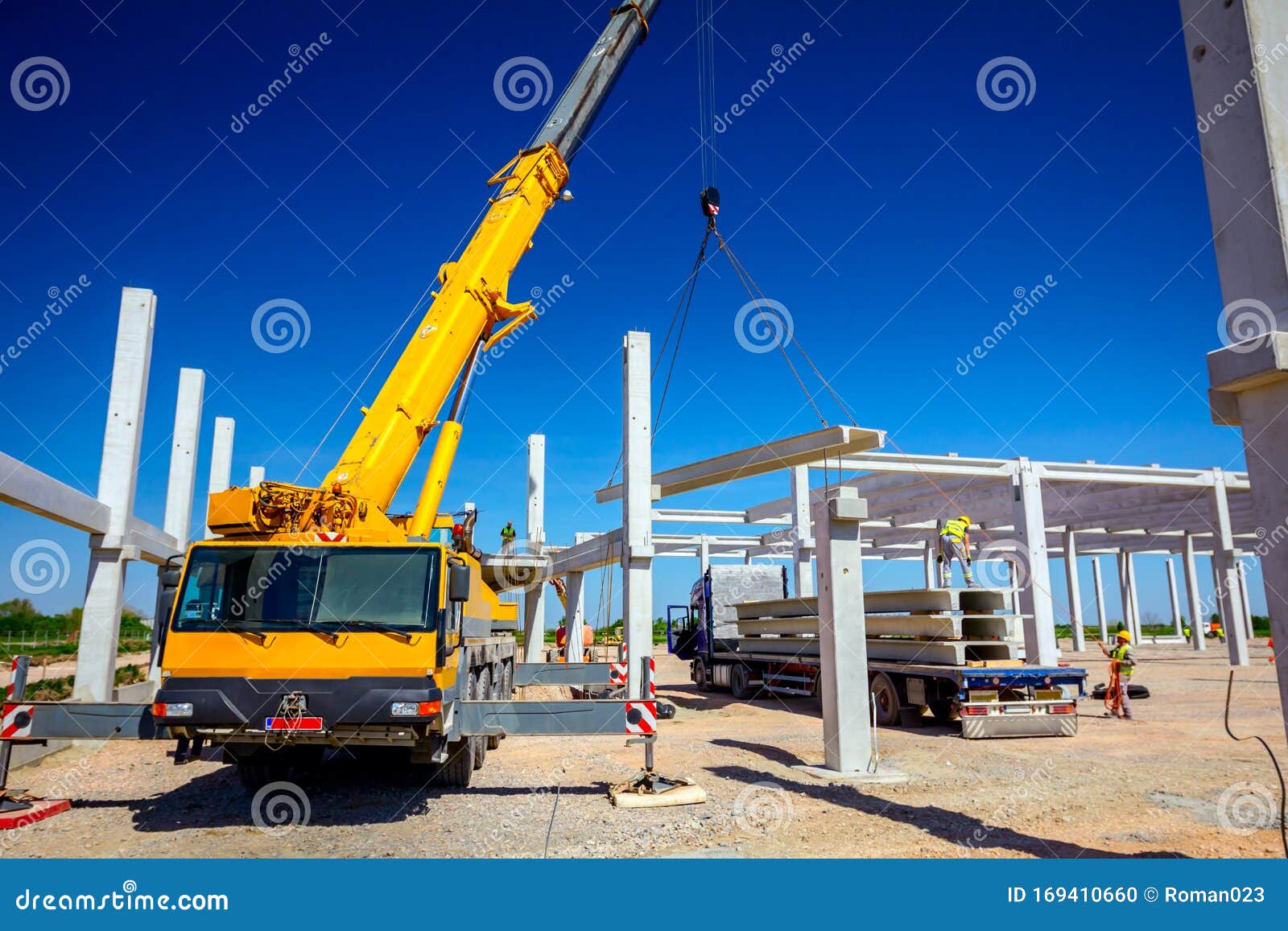 Unloading Concrete Pillar from Truck Trailer at Construction Site Stock ...