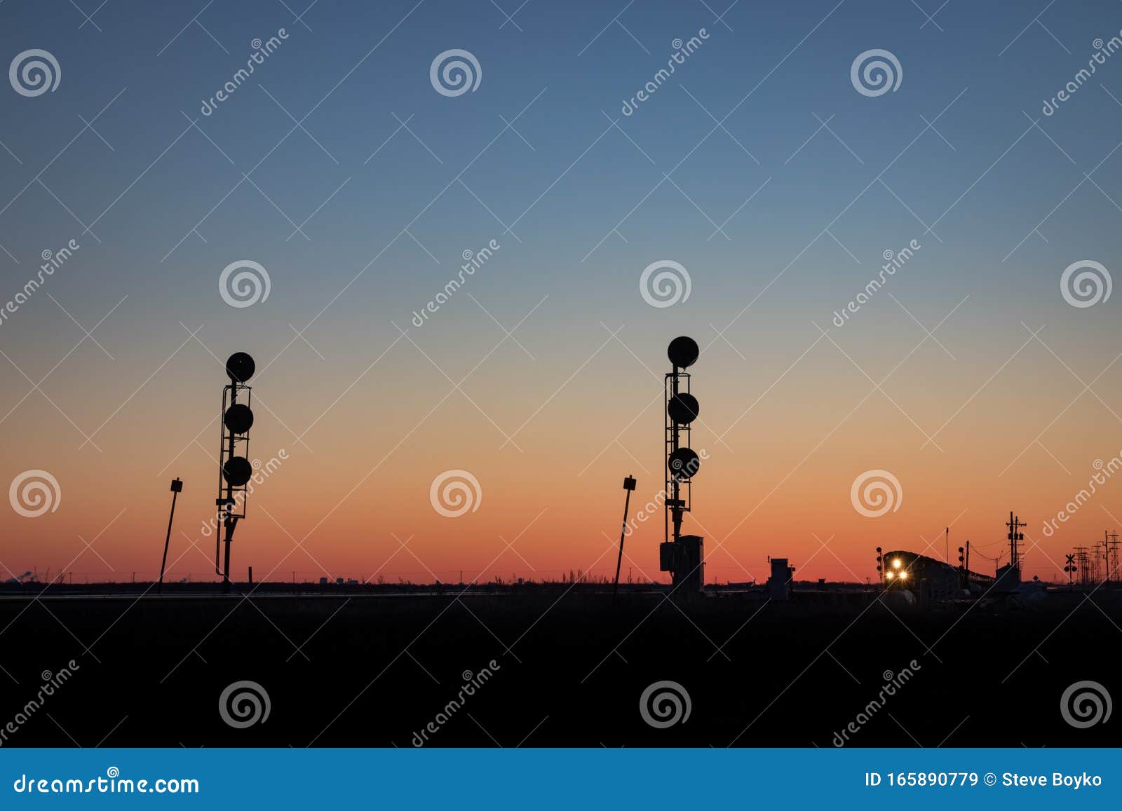 Train Approaching Railway Signals at Sunset on Canadian Prairie Stock ...