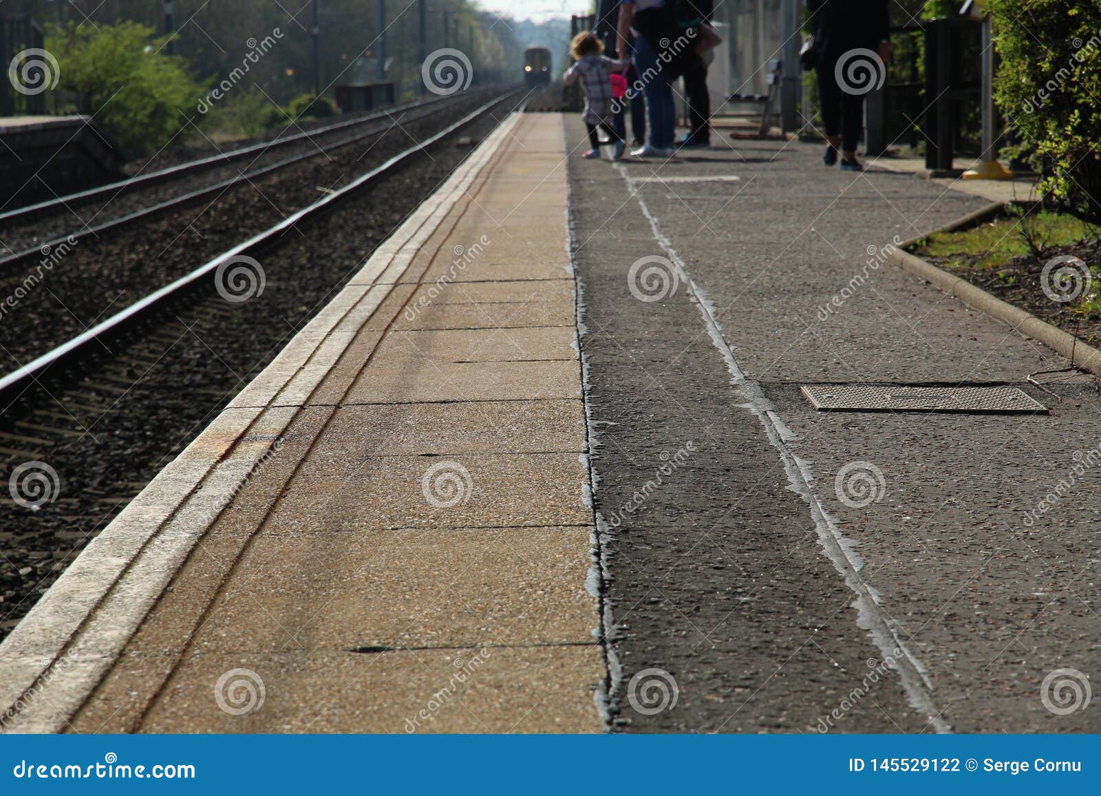 Train Approaching Station and People Waiting on Platform Stock Photo ...