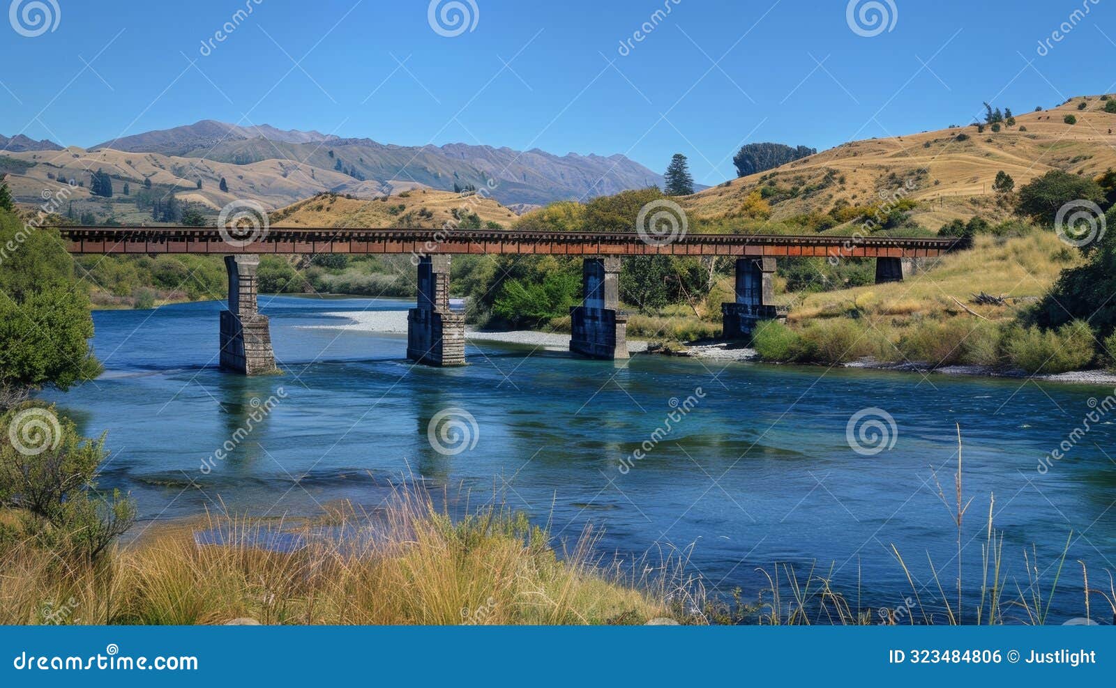 The Train Bridge Stretched Over a Deep Blue River Crossing into a New ...